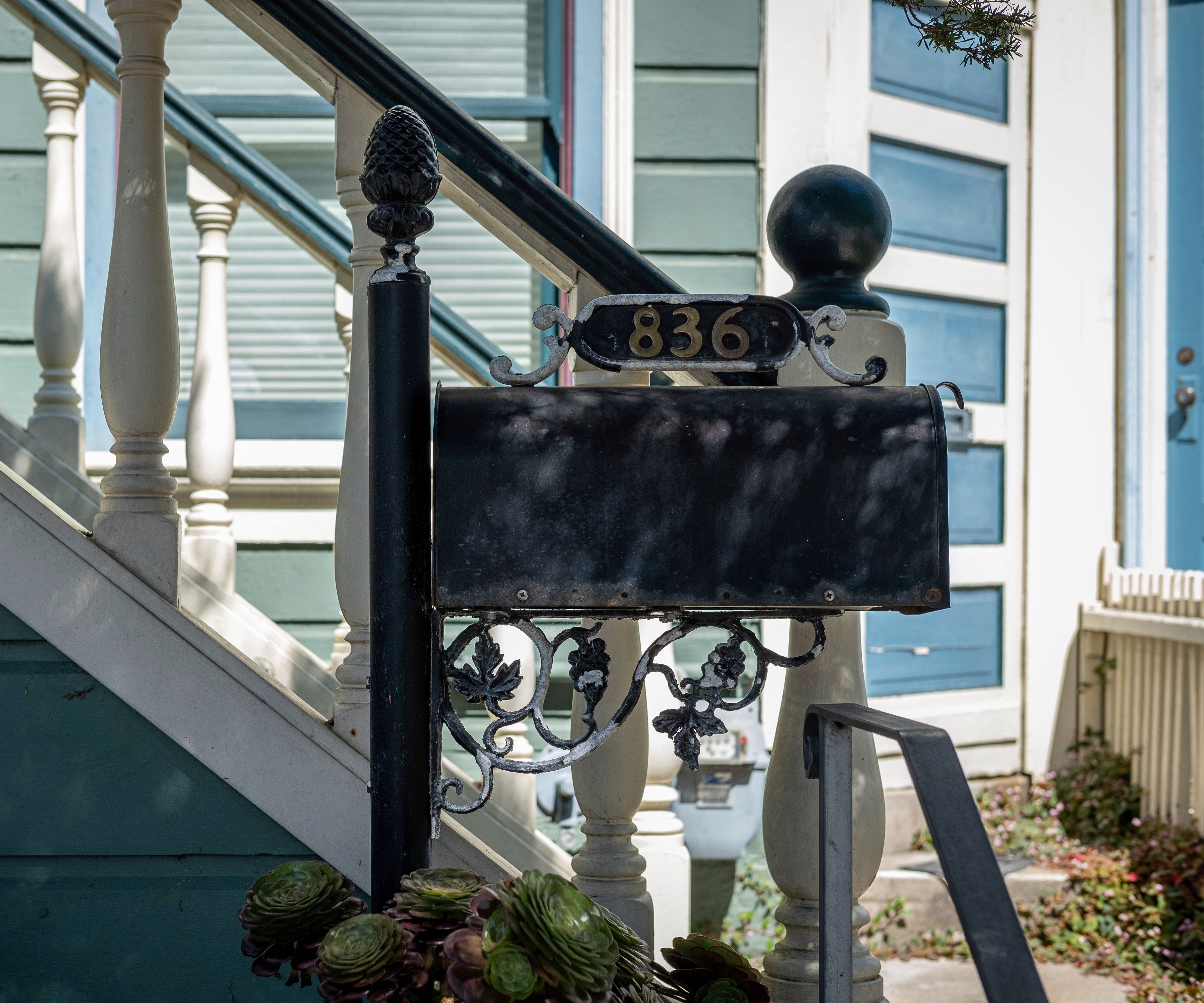 A mailbox is sitting on the steps of a house · Free Stock Photo