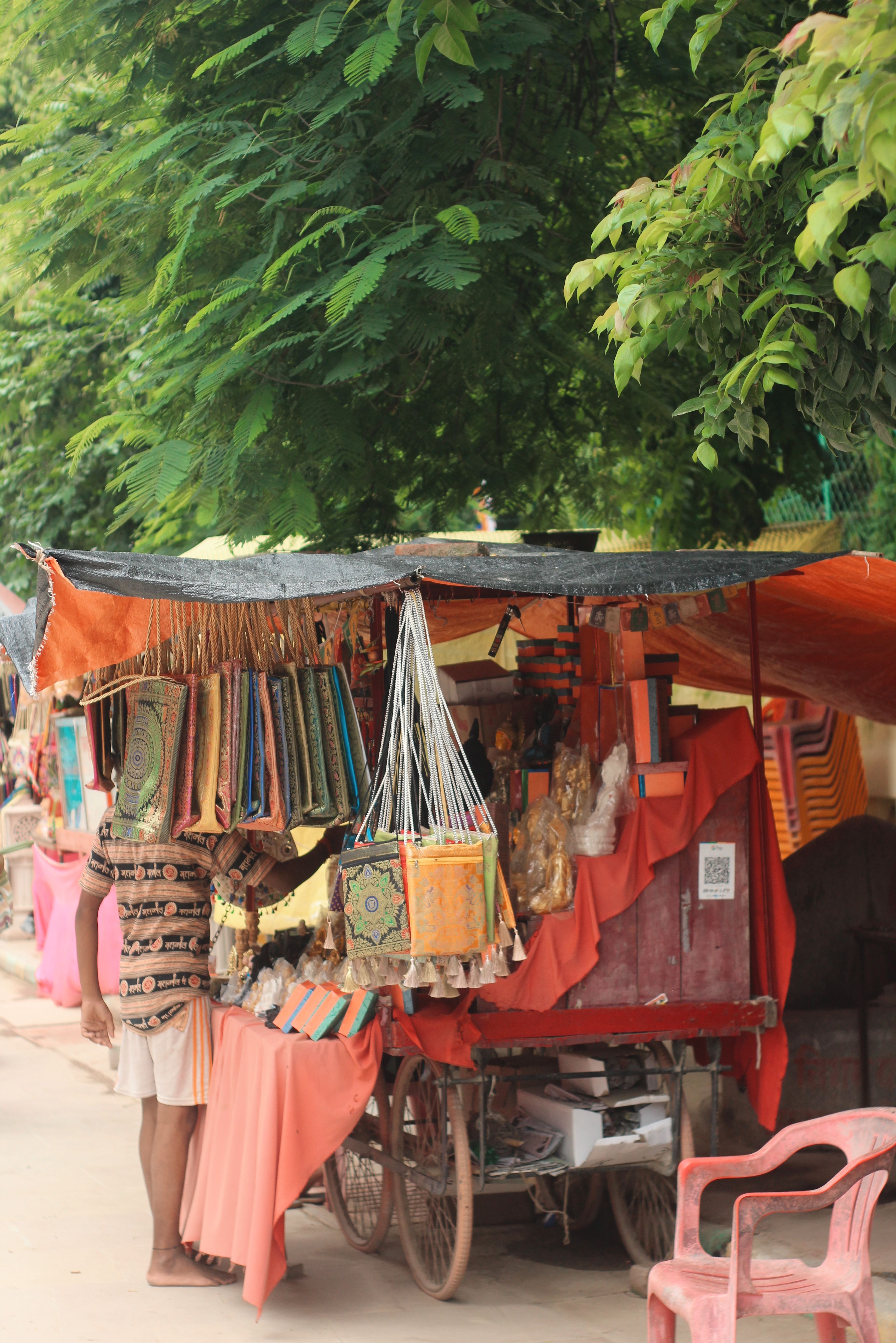 A man selling goods on a street · Free Stock Photo