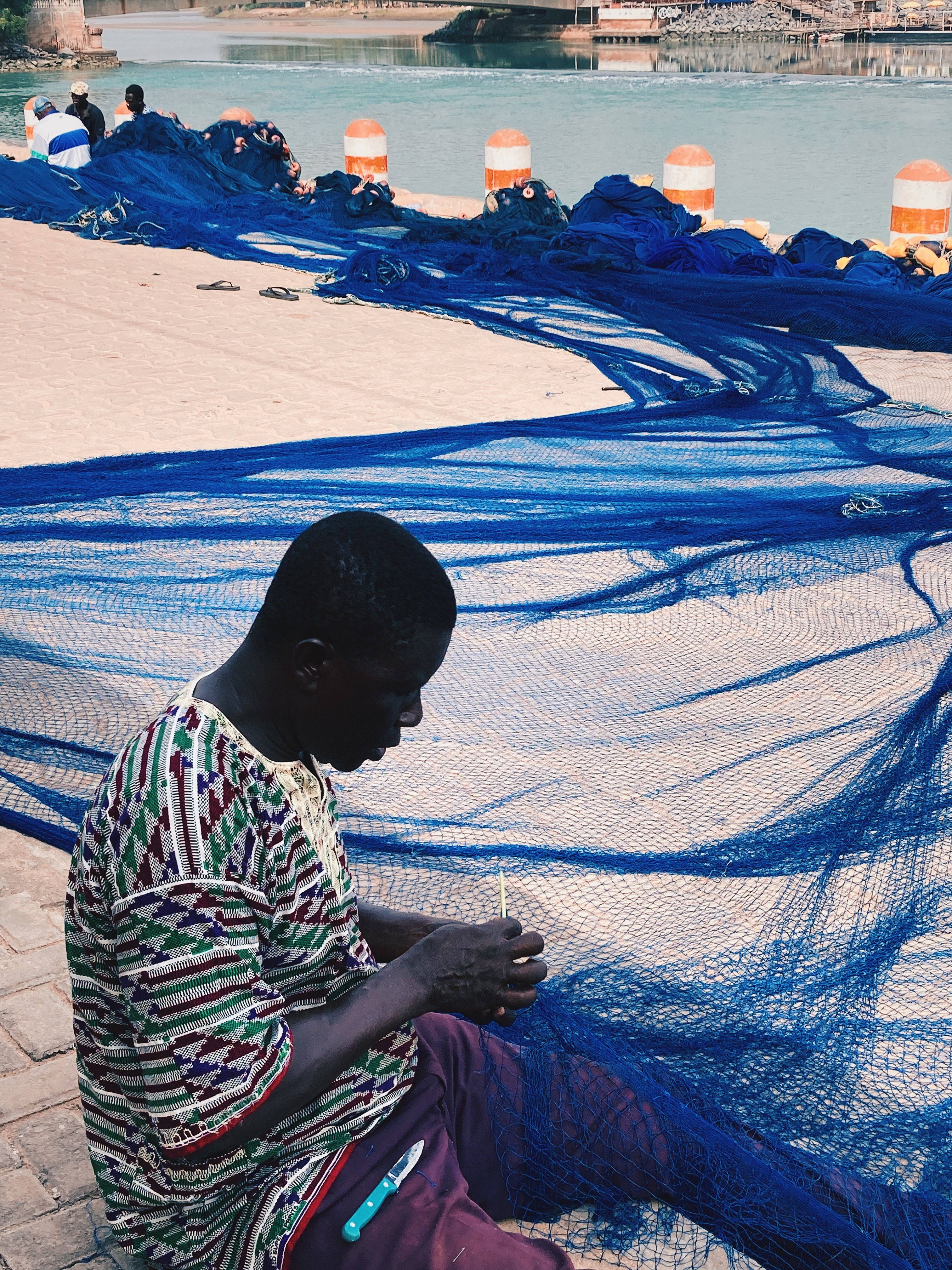 Mending nets · Free Stock Photo