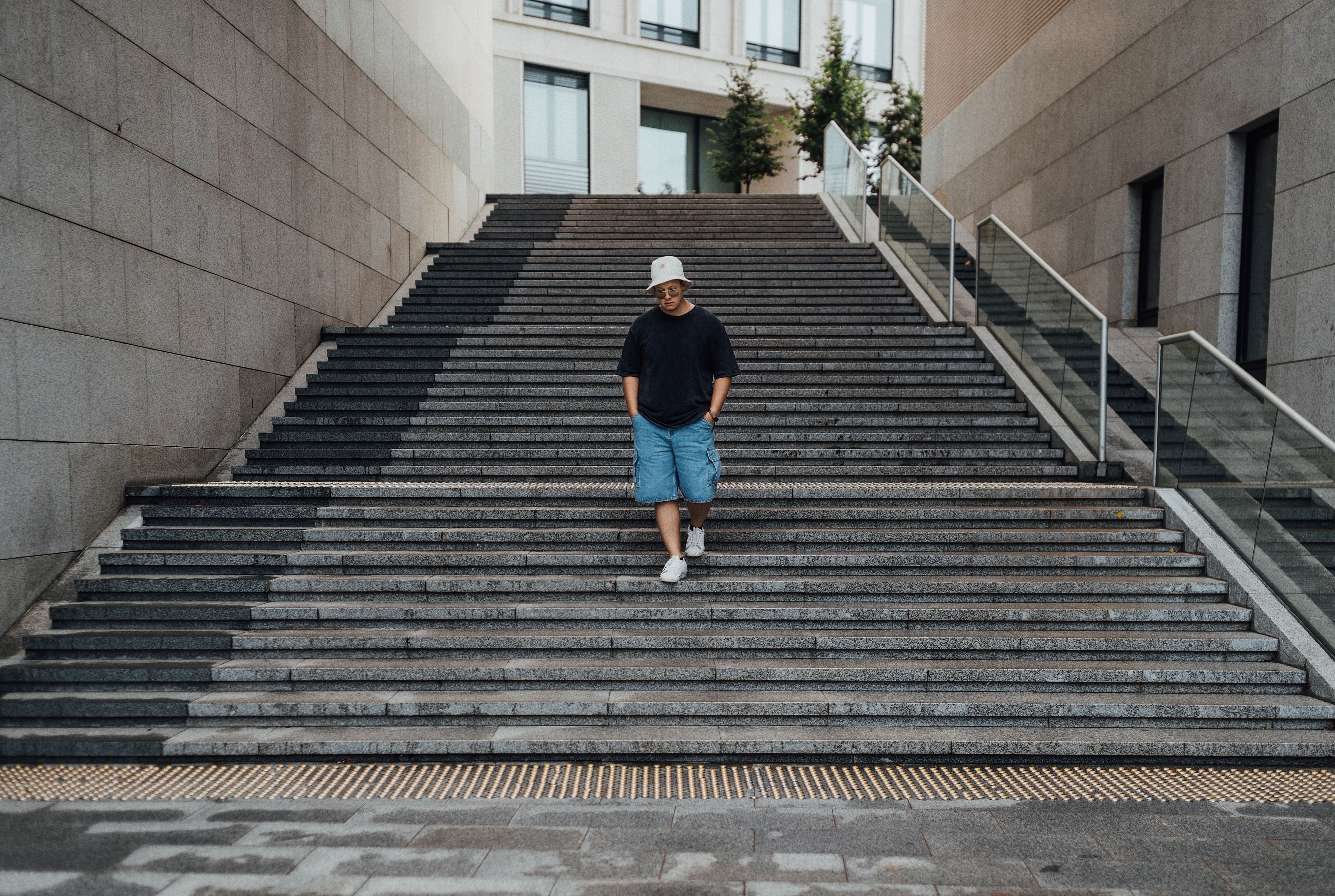 A man standing on the steps of a building · Free Stock Photo