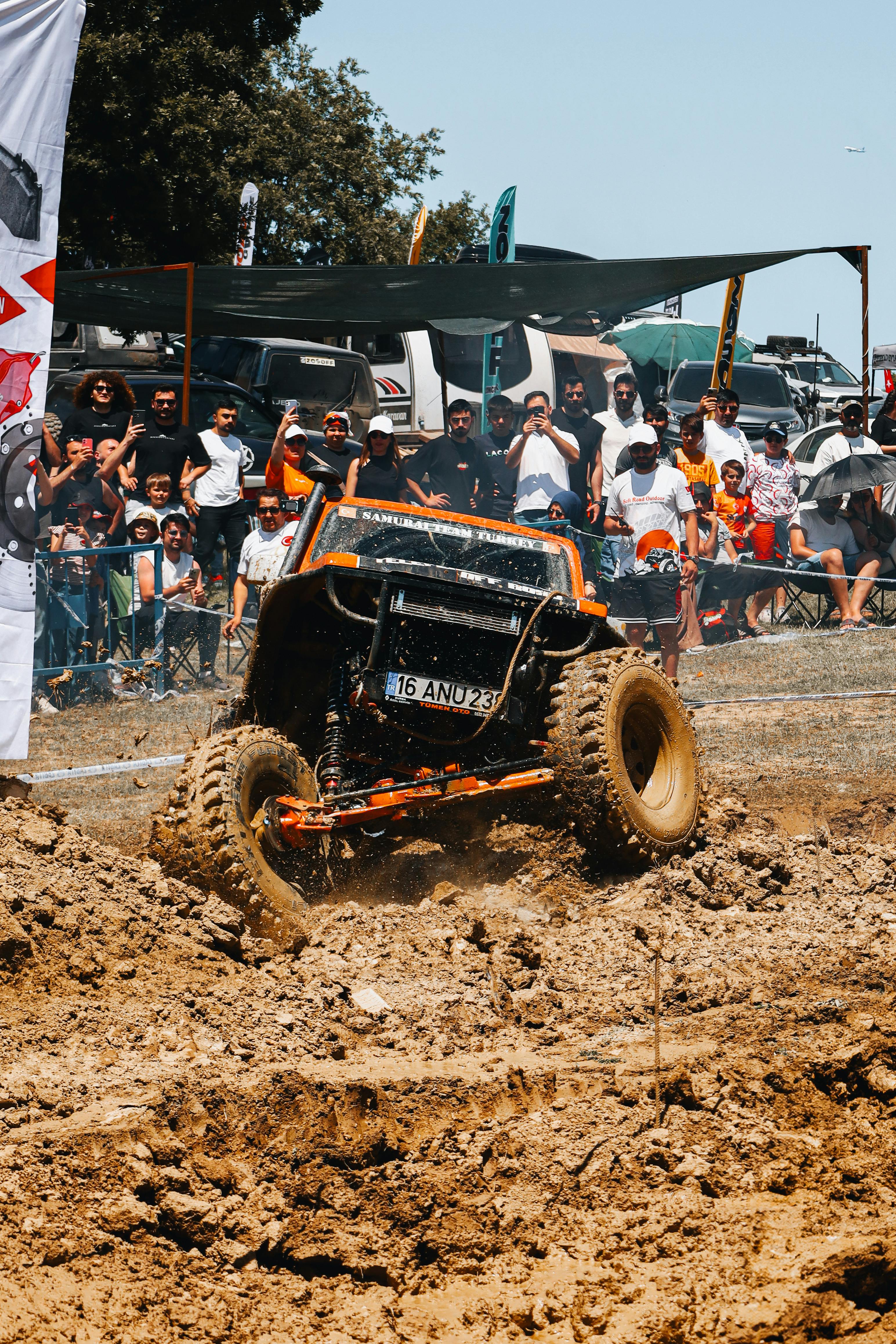 A man driving a truck through a muddy area · Free Stock Photo