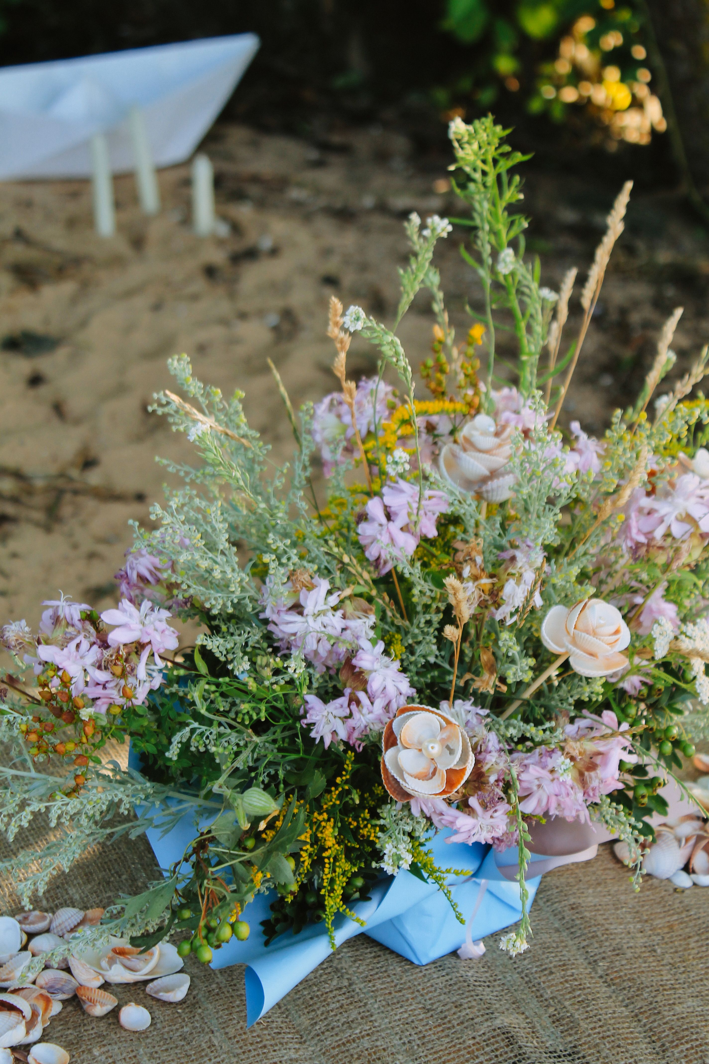 Elegant Floral Arrangement on Sandy Beach · Free Stock Photo