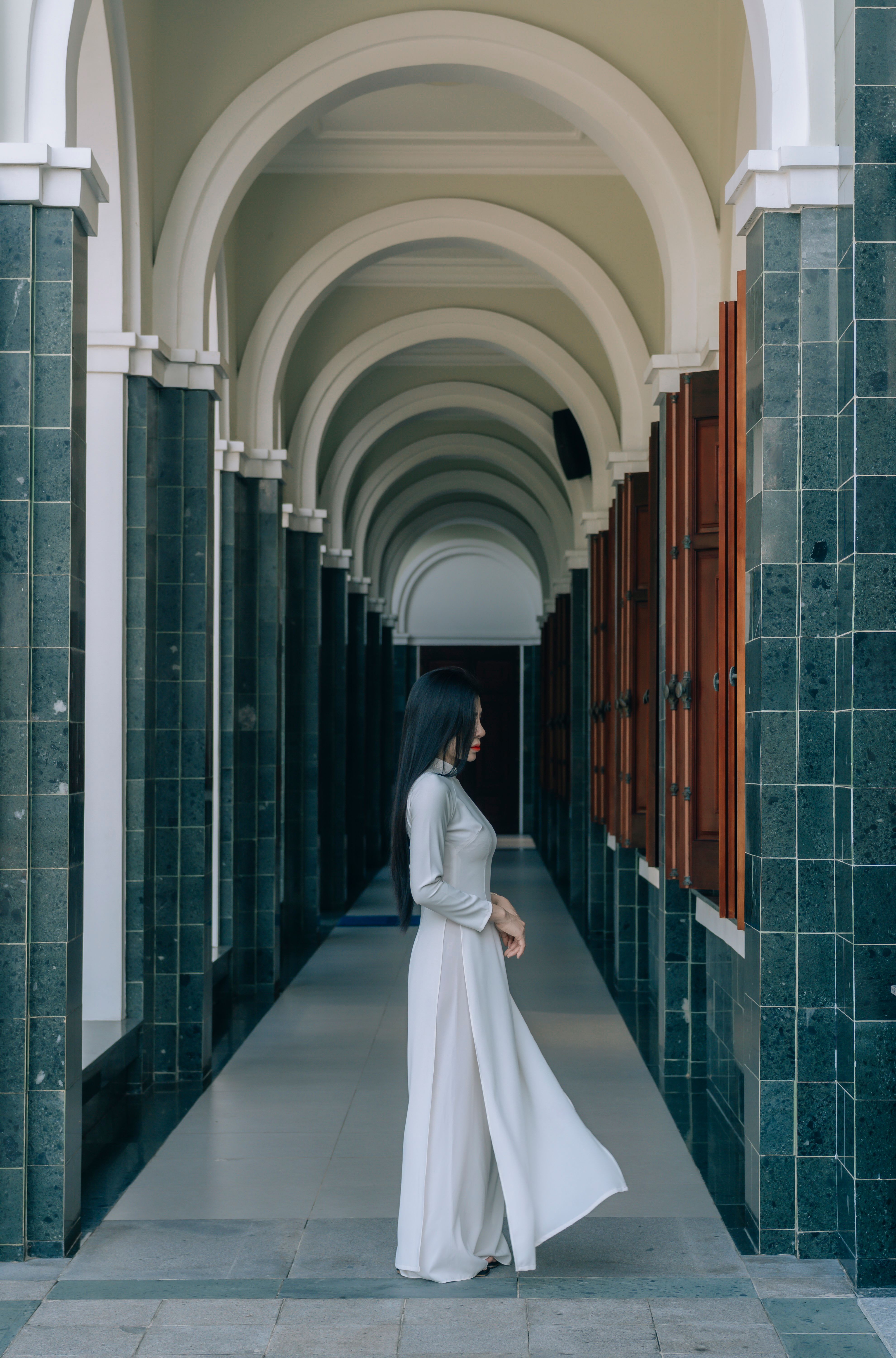 Woman Walking Under Historic Arches in Istanbul · Free Stock Photo