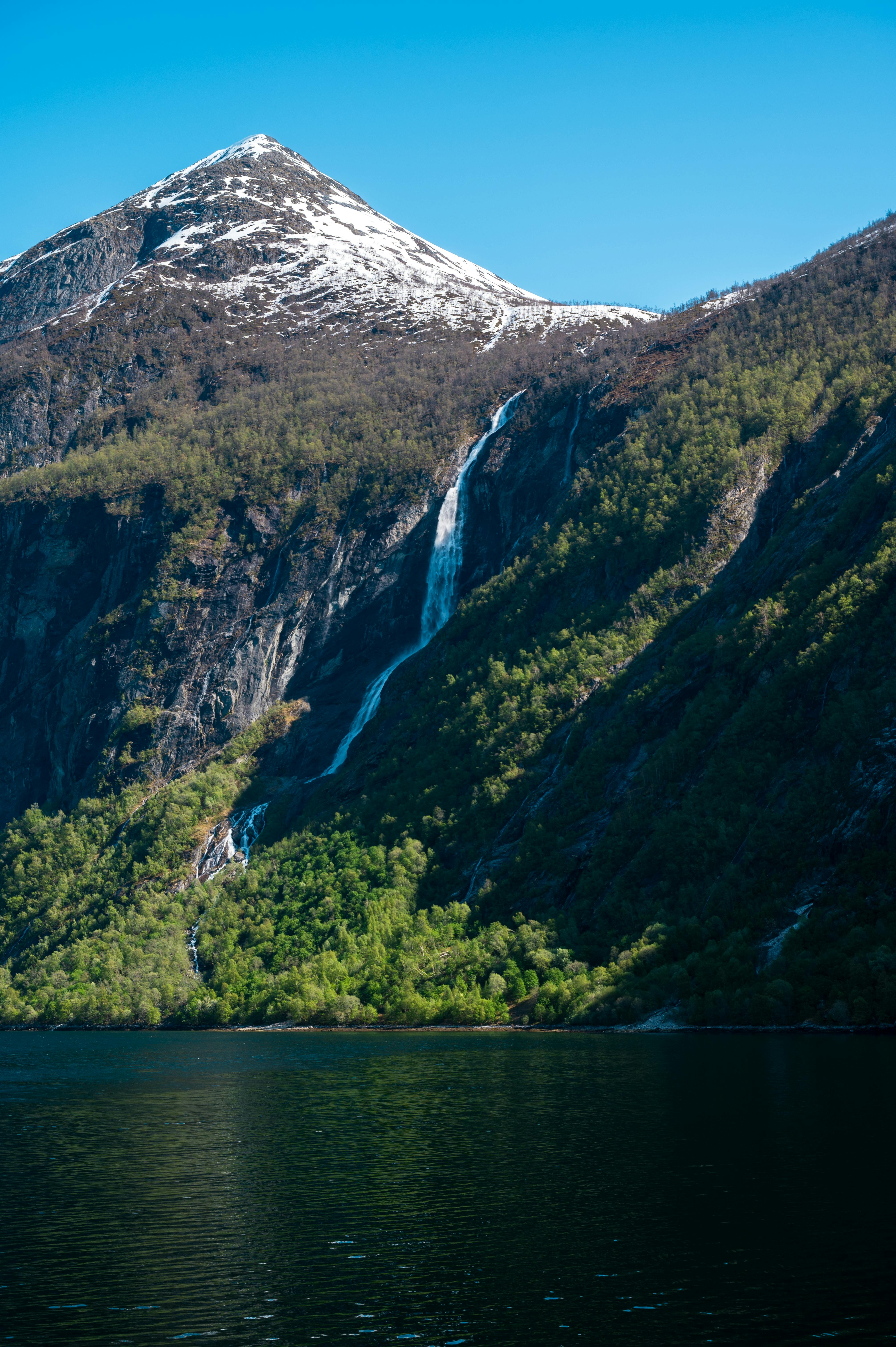 Brown Calm Body of Water Near Mountains Under Blue Sky at Daytime ...