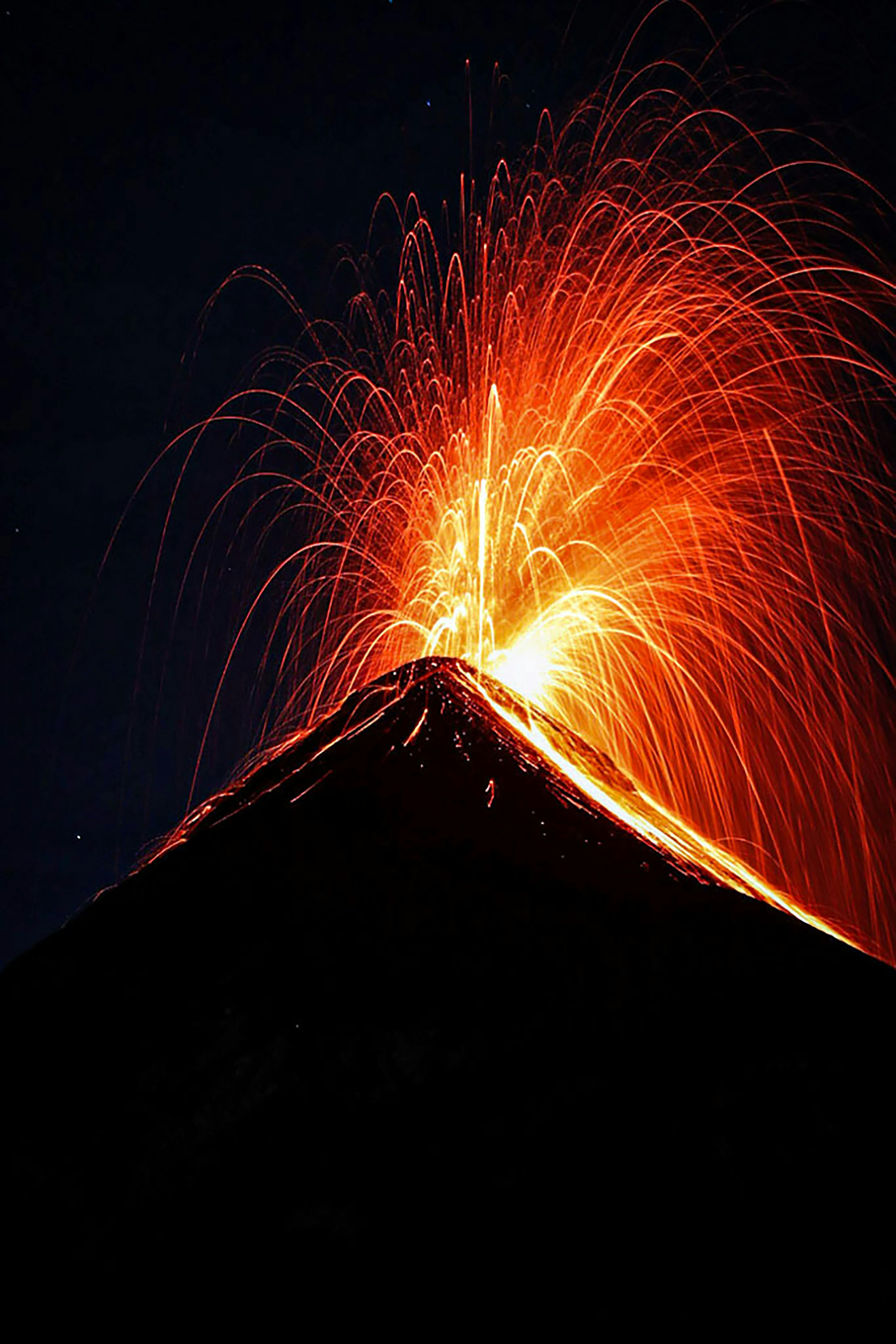 Volcano Erupting at Night Under Starry Sky · Free Stock Photo
