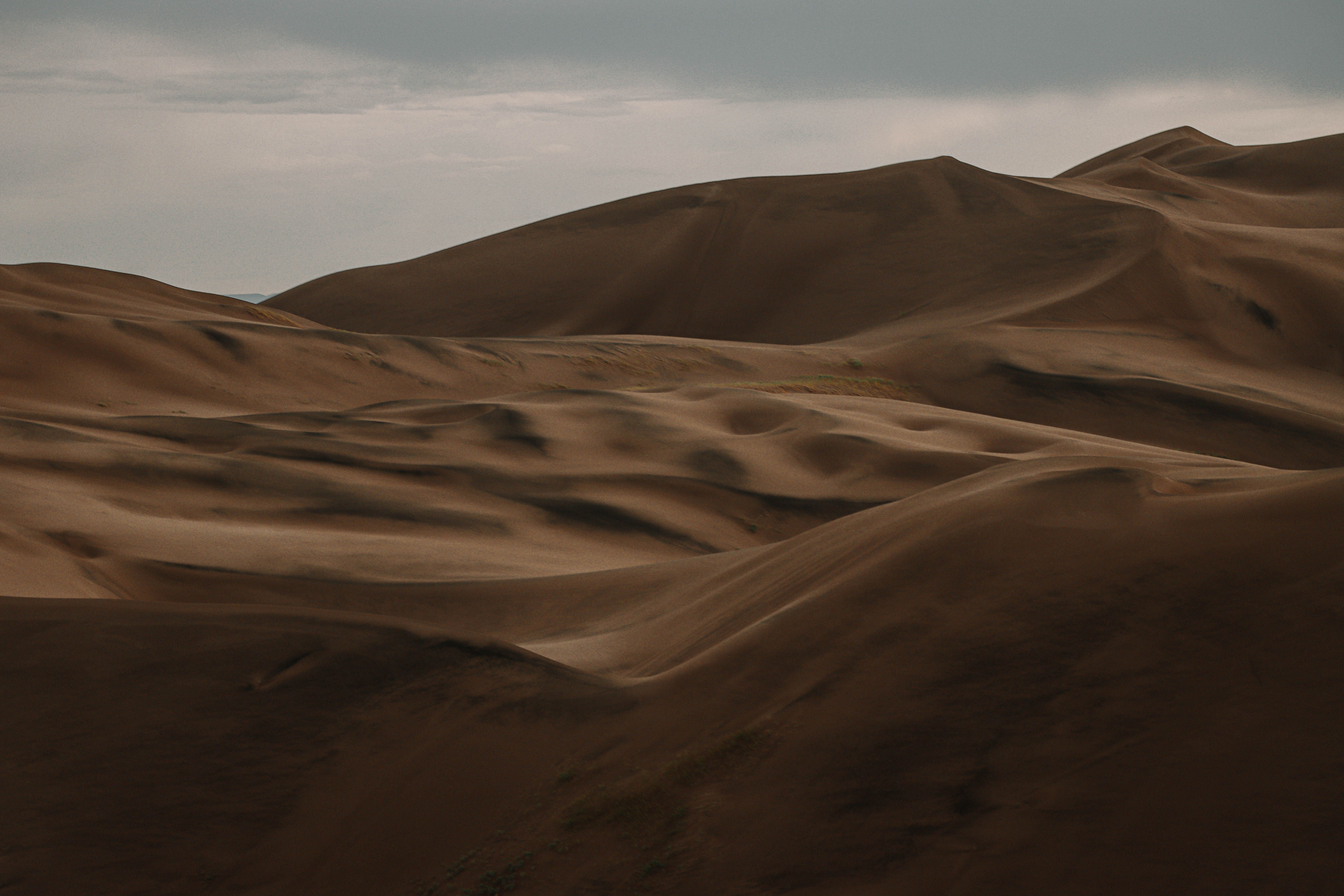 A desert landscape with some sand dunes · Free Stock Photo