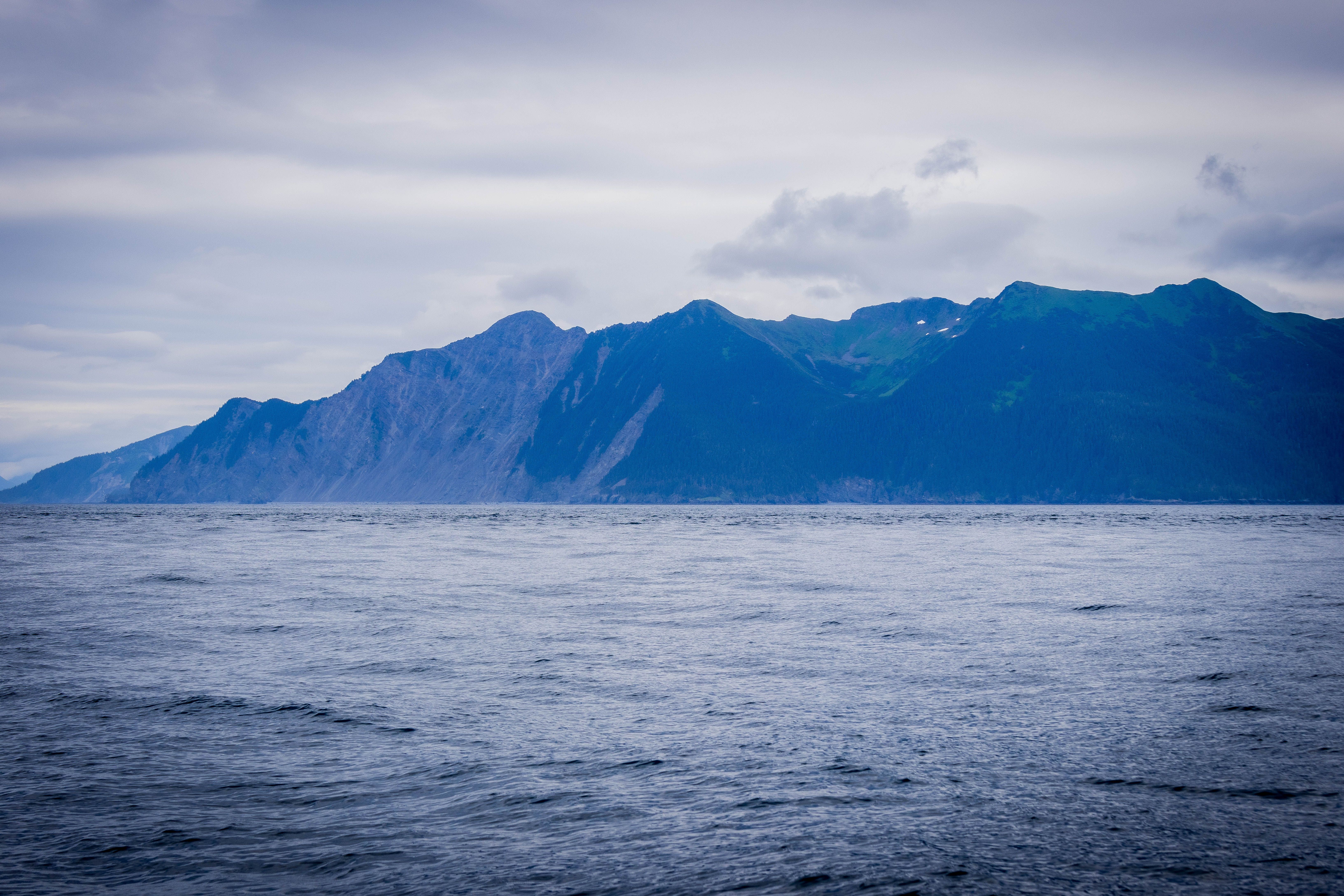 A view of the ocean and mountains from a boat · Free Stock Photo
