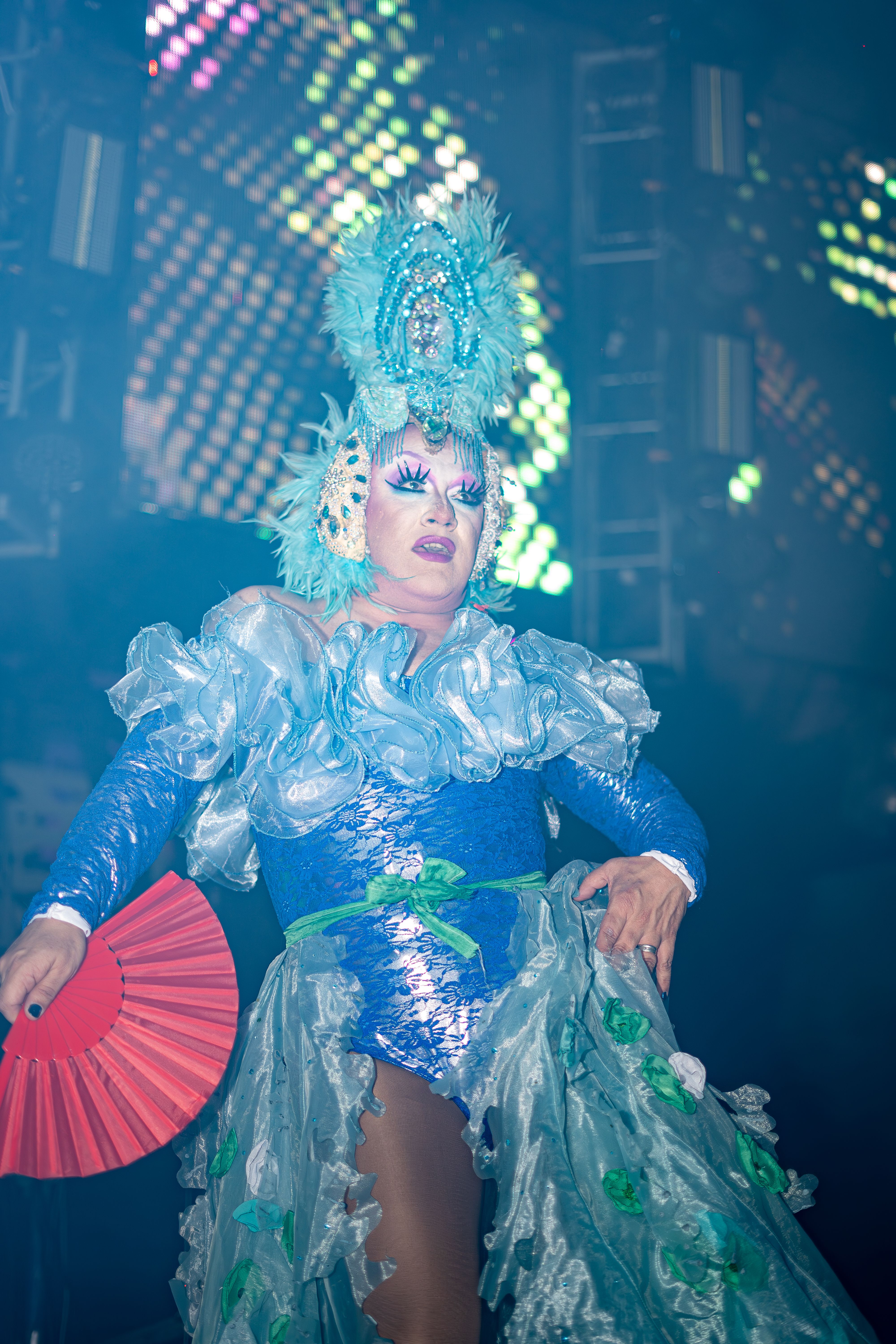 A drag queen in a blue costume with a fan · Free Stock Photo