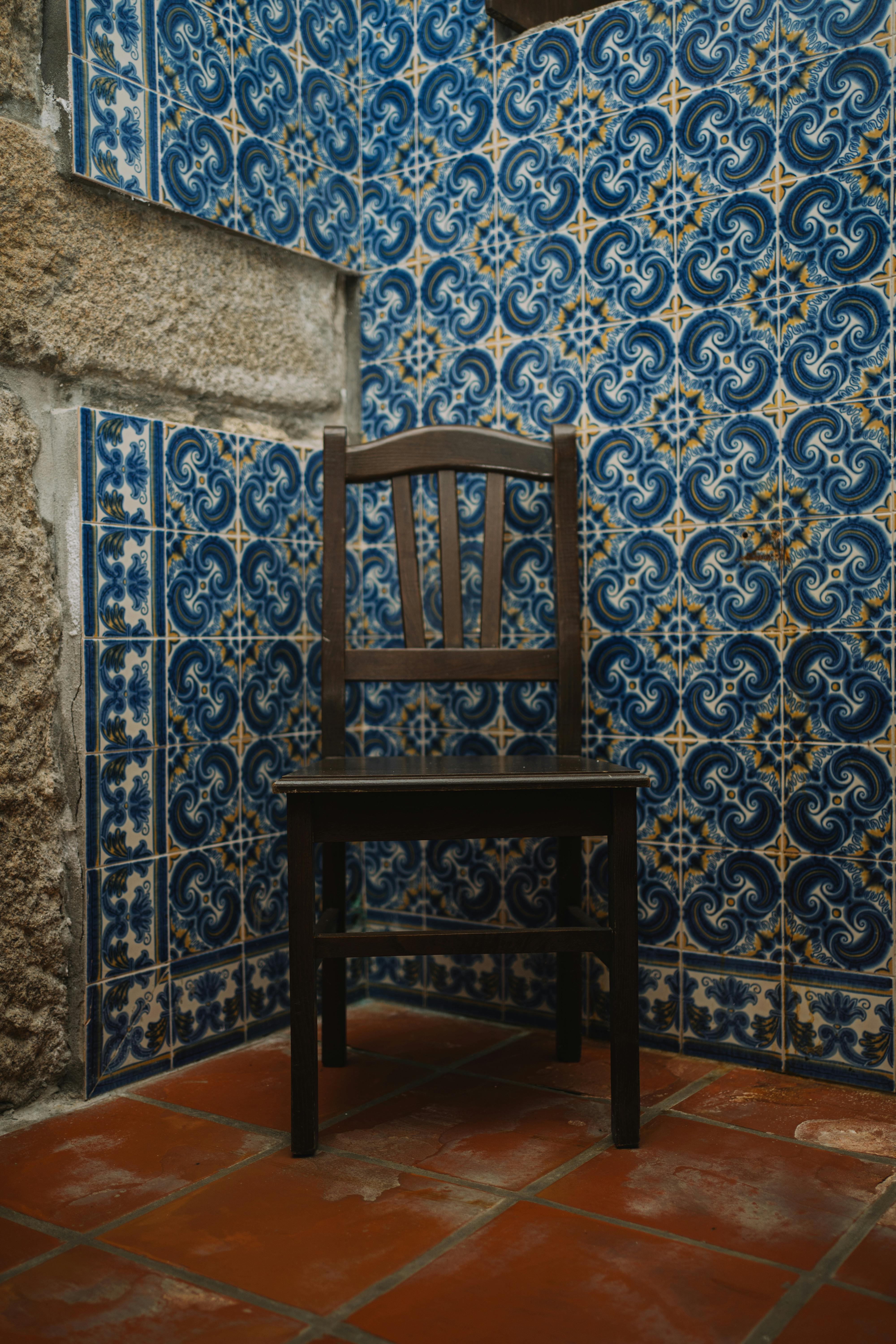 A chair in a room with blue and white tiles · Free Stock Photo