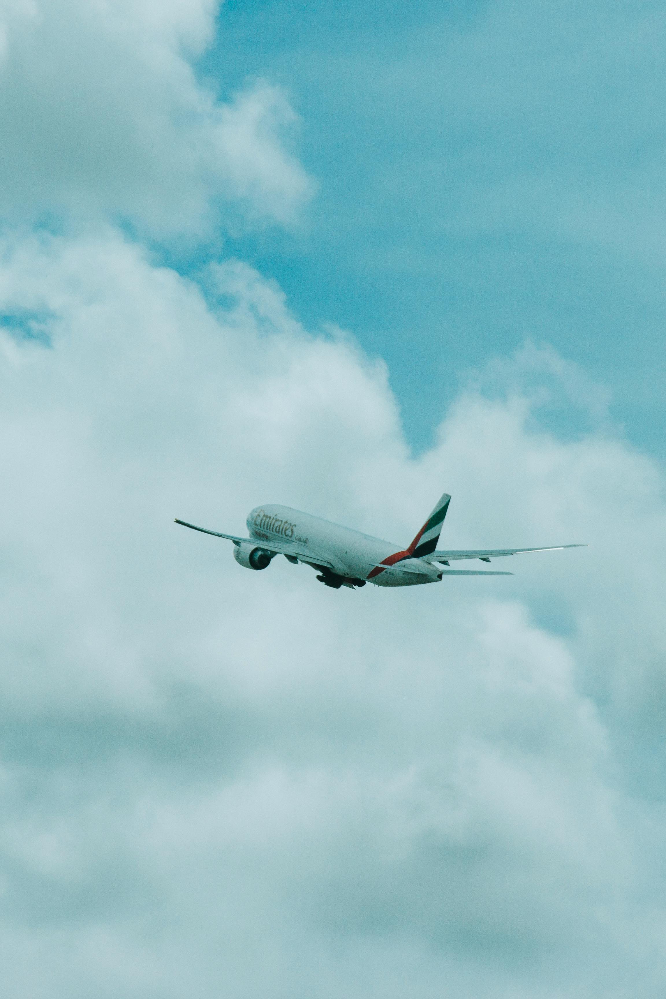 A large airplane flying through the sky · Free Stock Photo