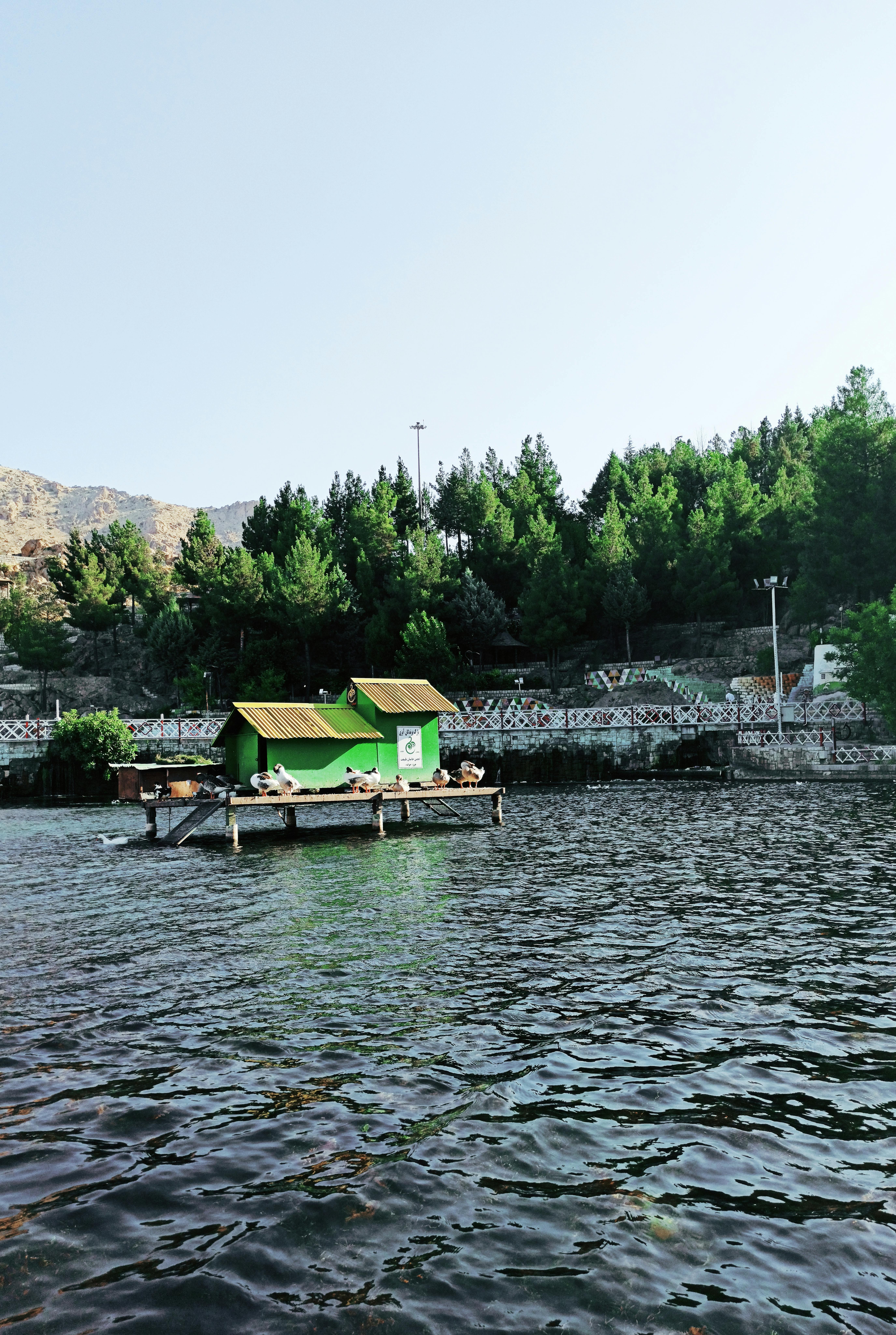 A small house on a dock in the middle of a lake · Free Stock Photo