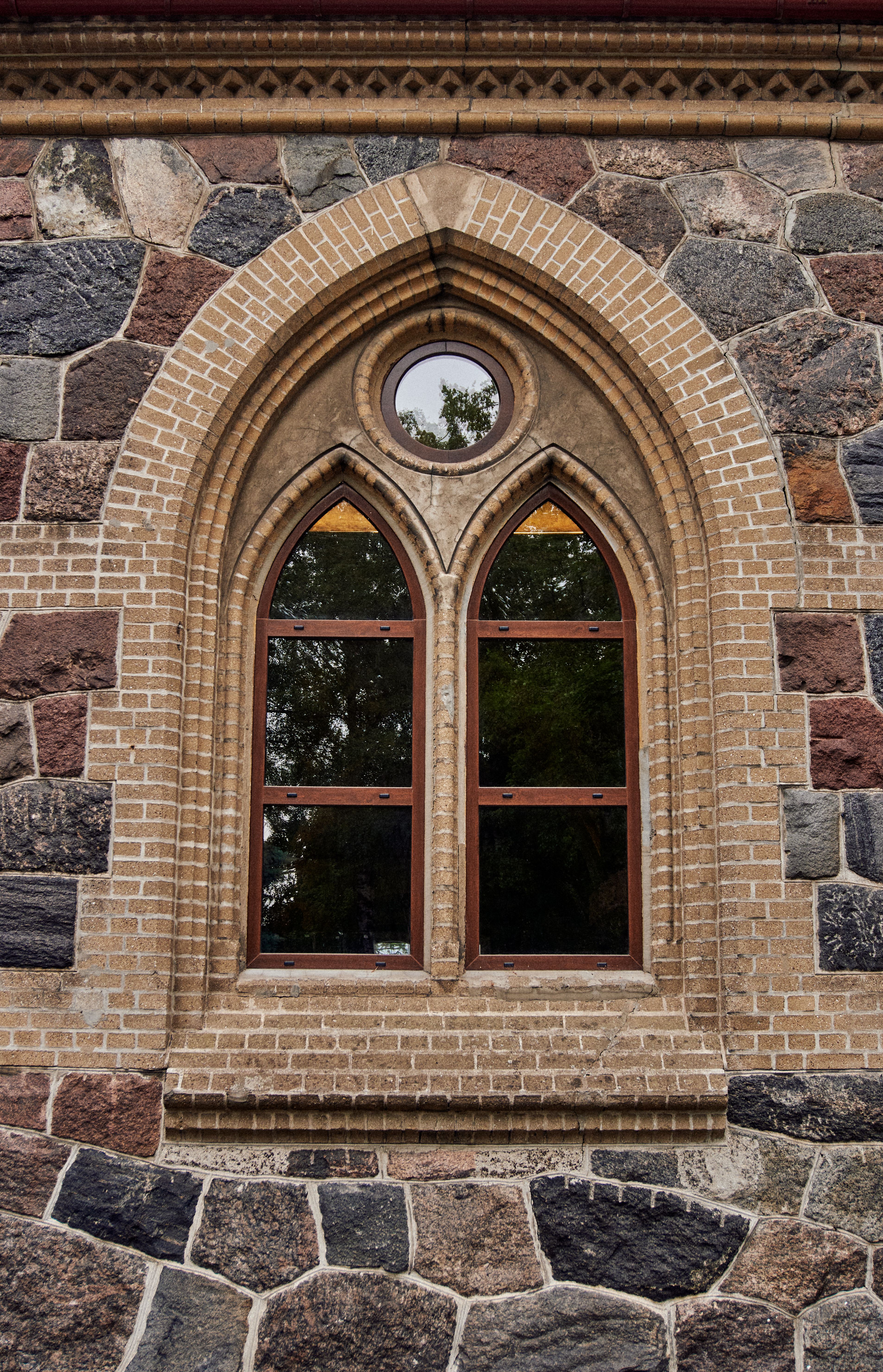 A window with a stone wall and a reflection · Free Stock Photo