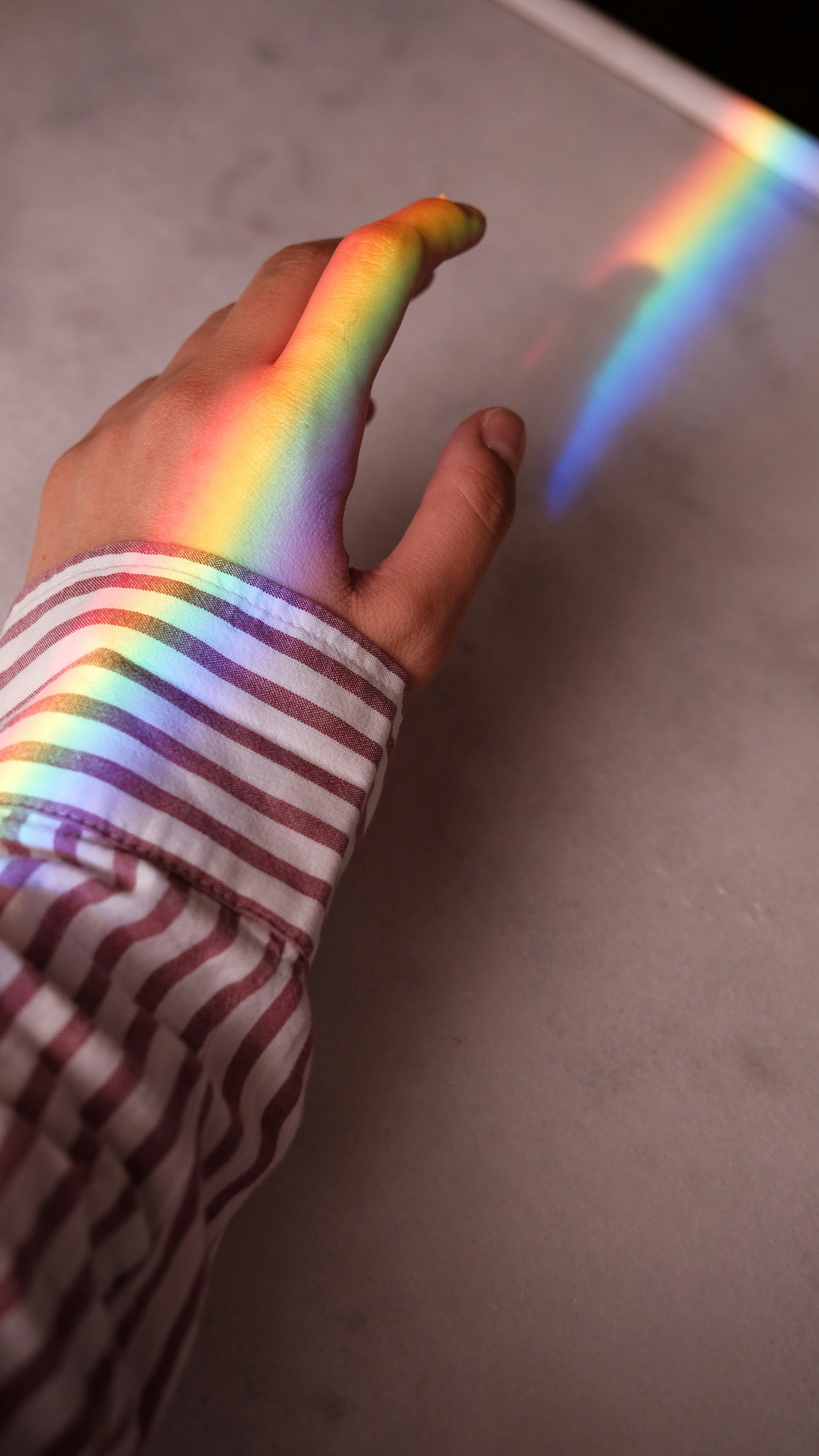 Blue and Orange Light Projeced on Left Hand of Person · Free Stock Photo