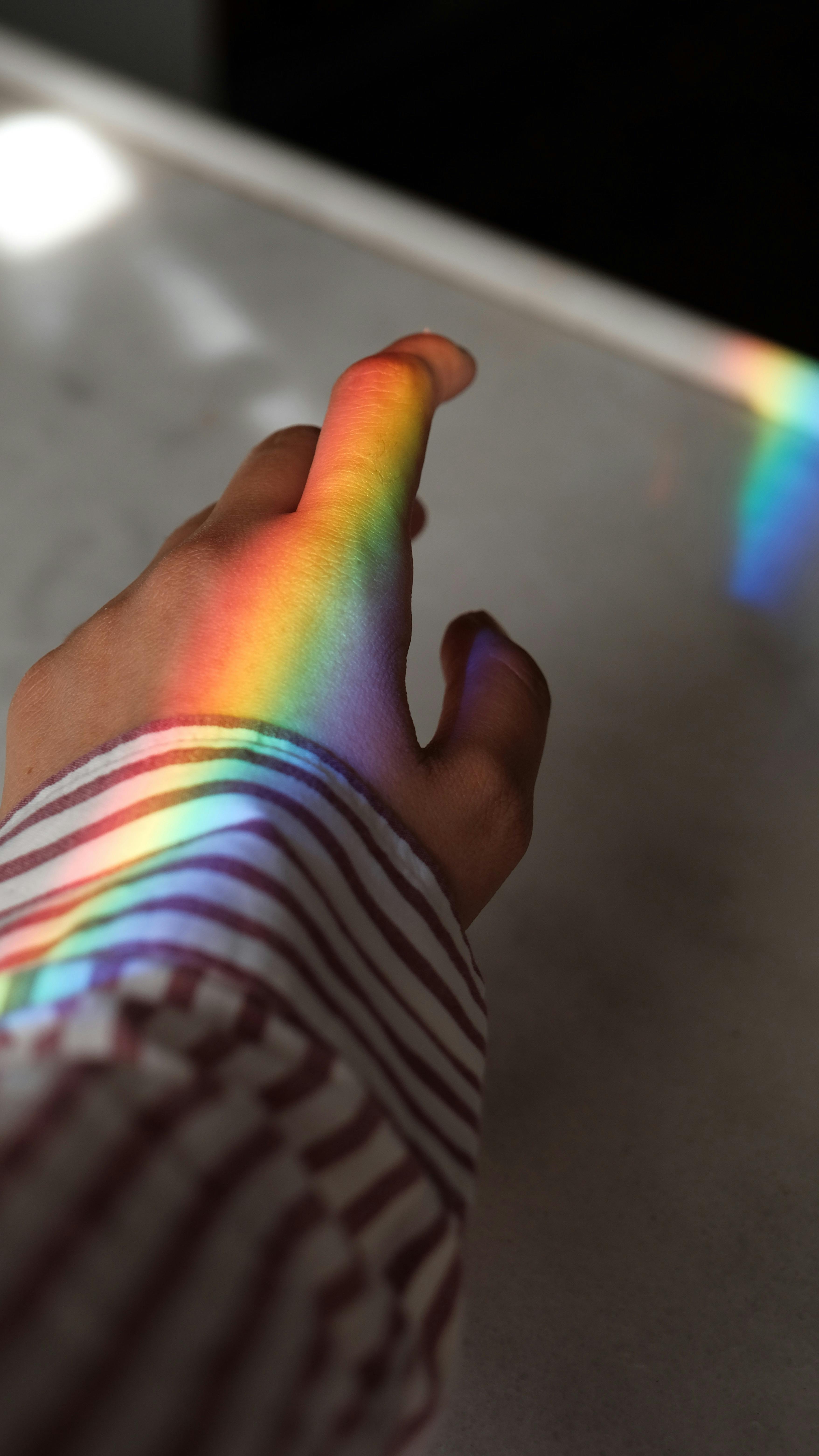 Blue and Orange Light Projeced on Left Hand of Person · Free Stock Photo