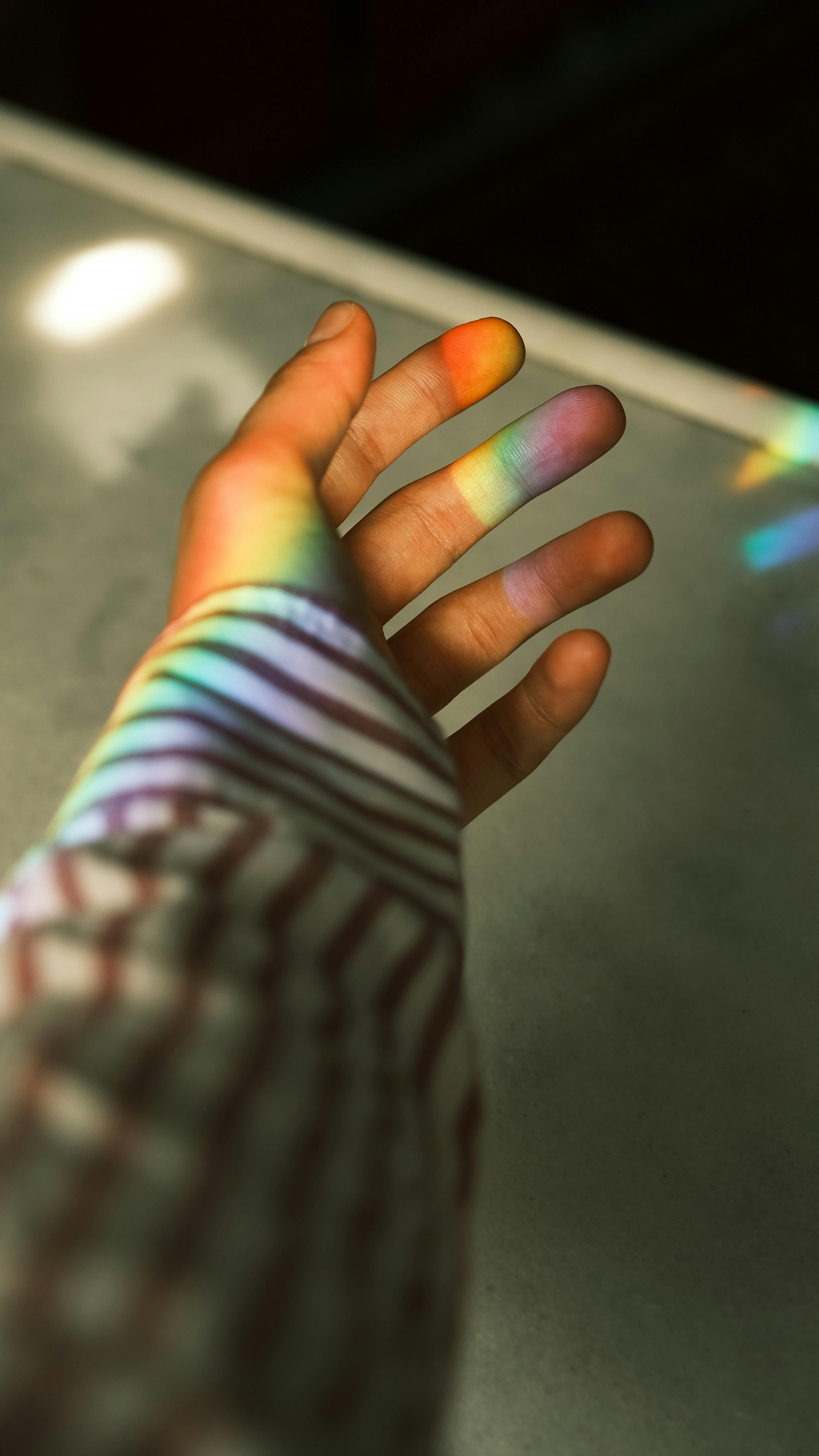 Blue and Orange Light Projeced on Left Hand of Person · Free Stock Photo