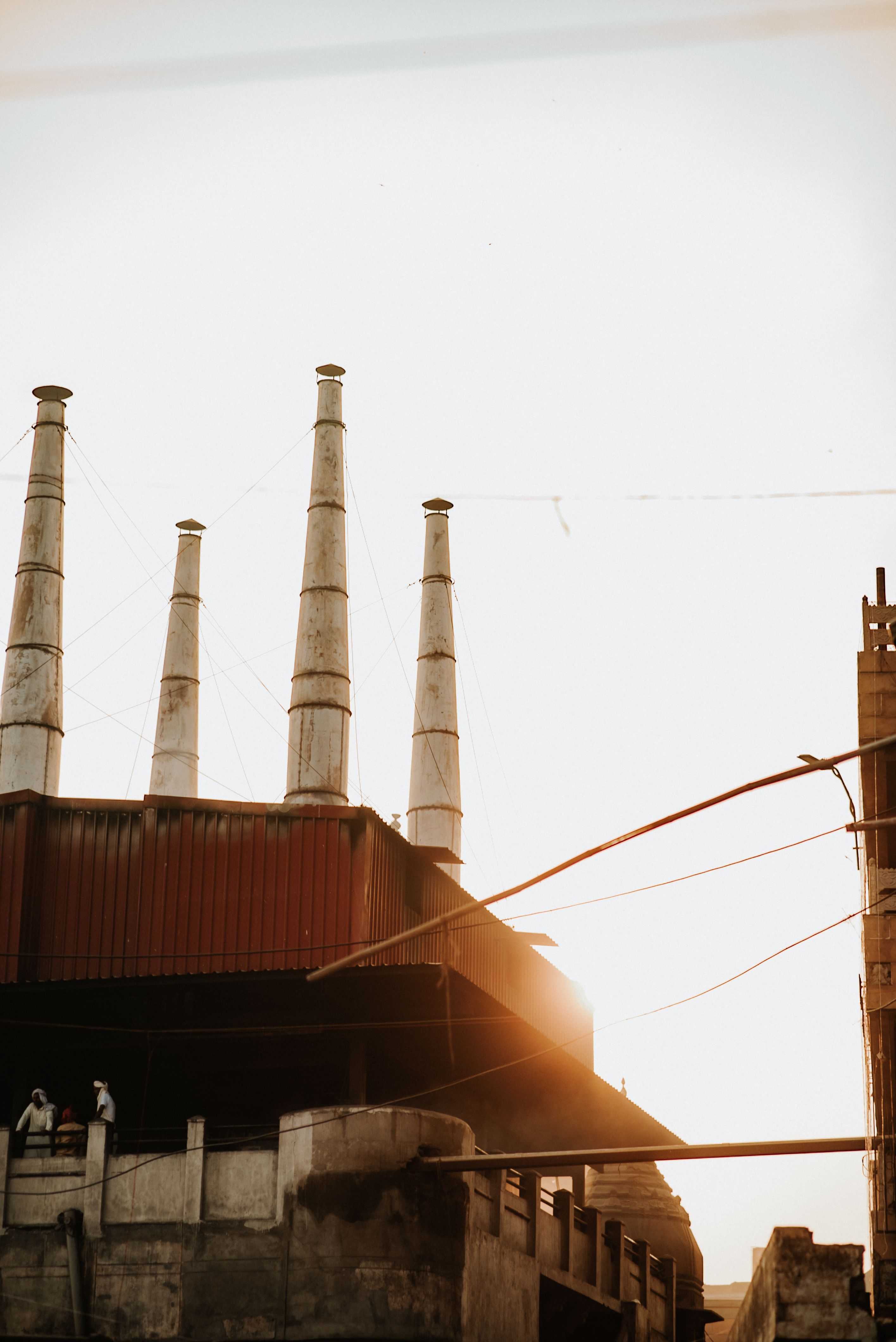 A photo of a building with smoke stacks · Free Stock Photo