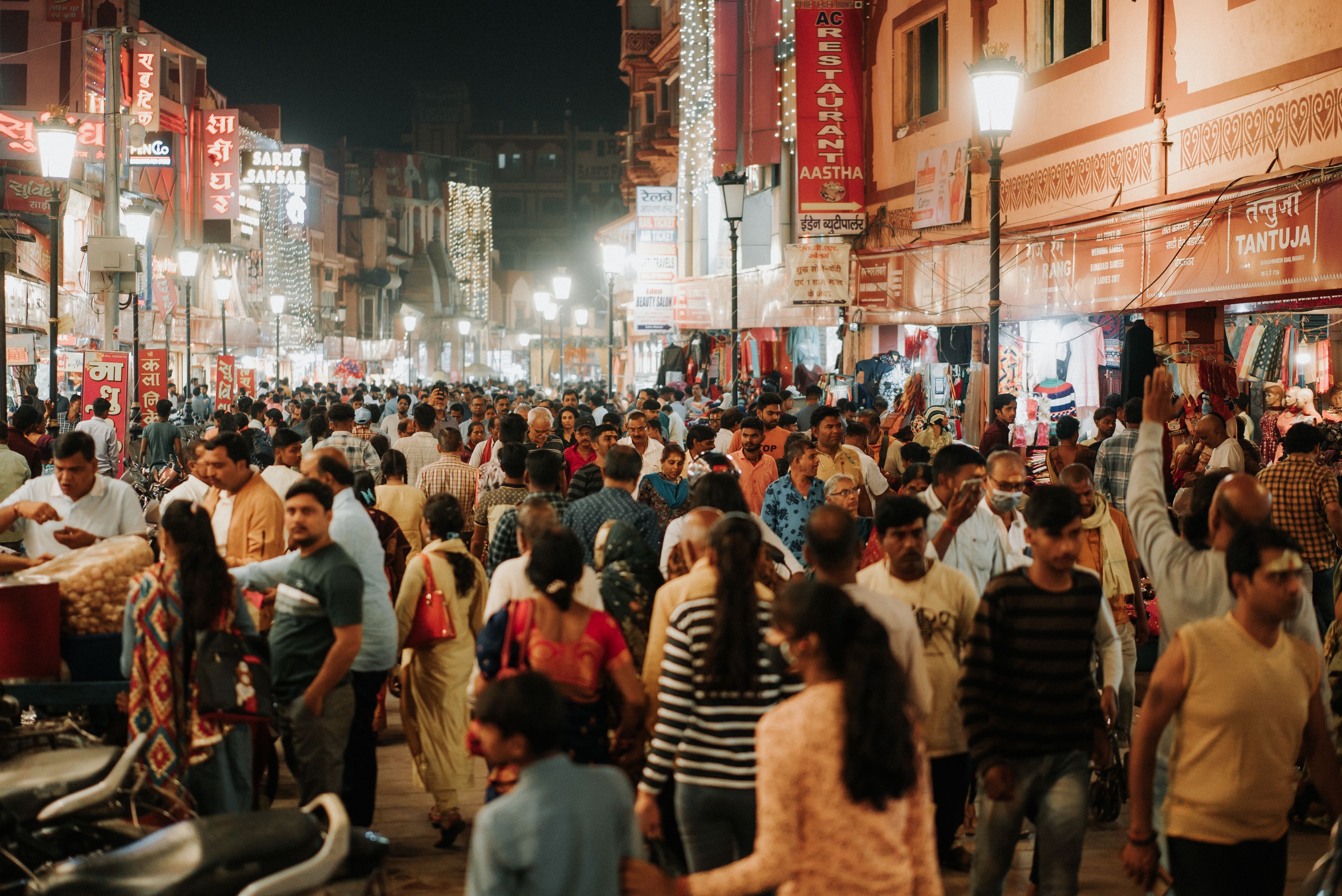 People are walking down a crowded street at night · Free Stock Photo