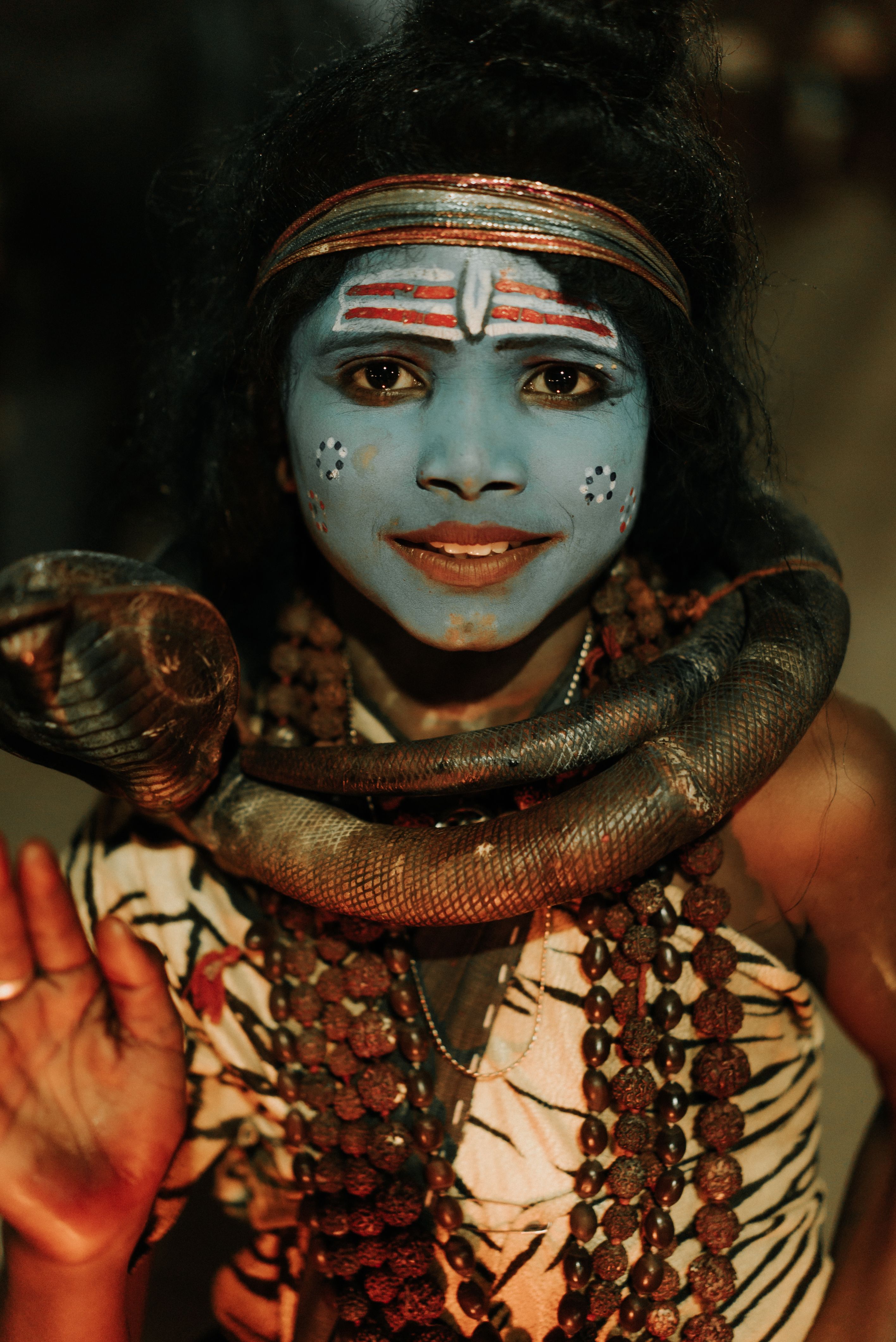 Portrait of Woman with Face painted Blue and Cobra Snake around Neck ...