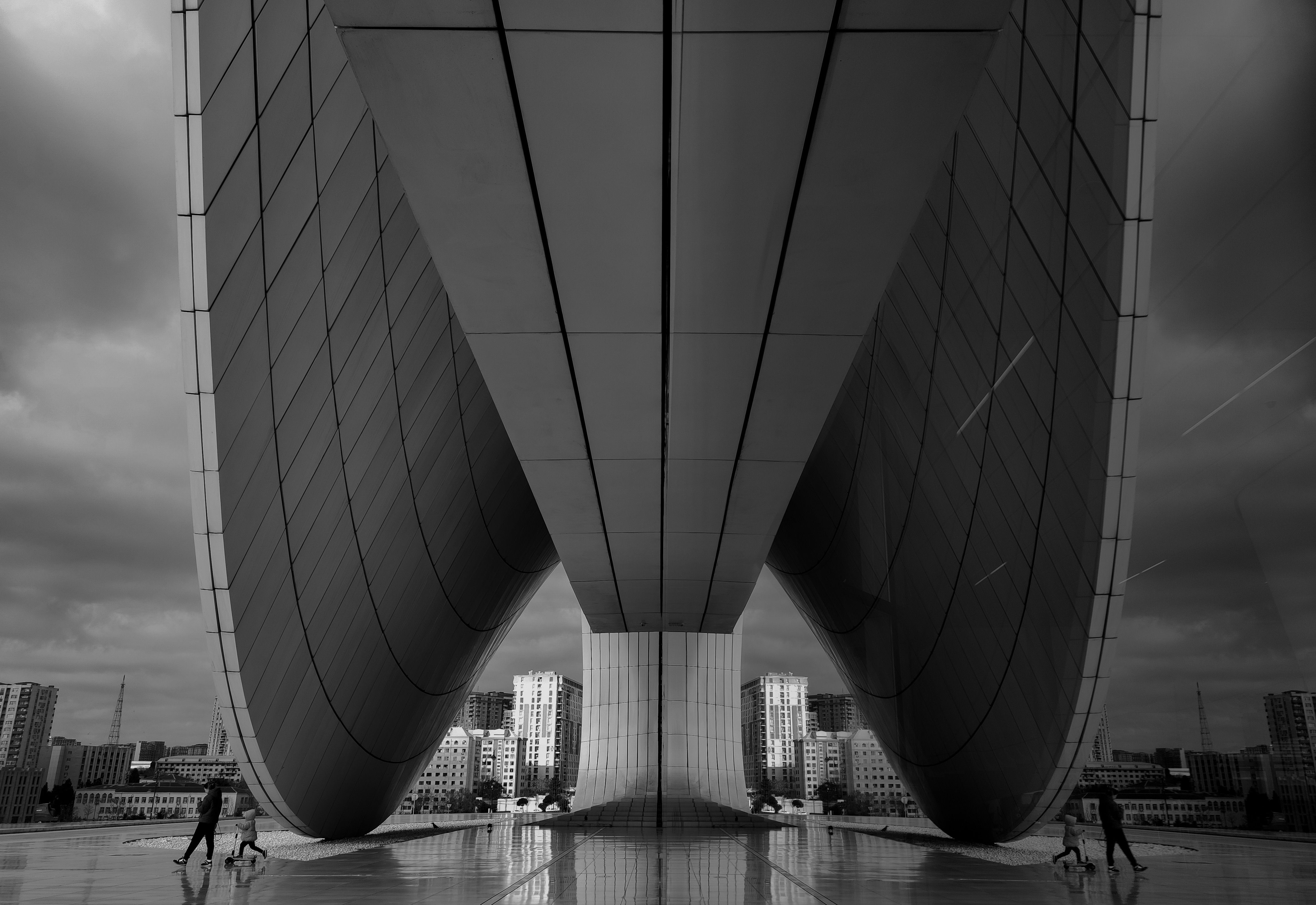 Black and white photo of people walking under a large building · Free ...