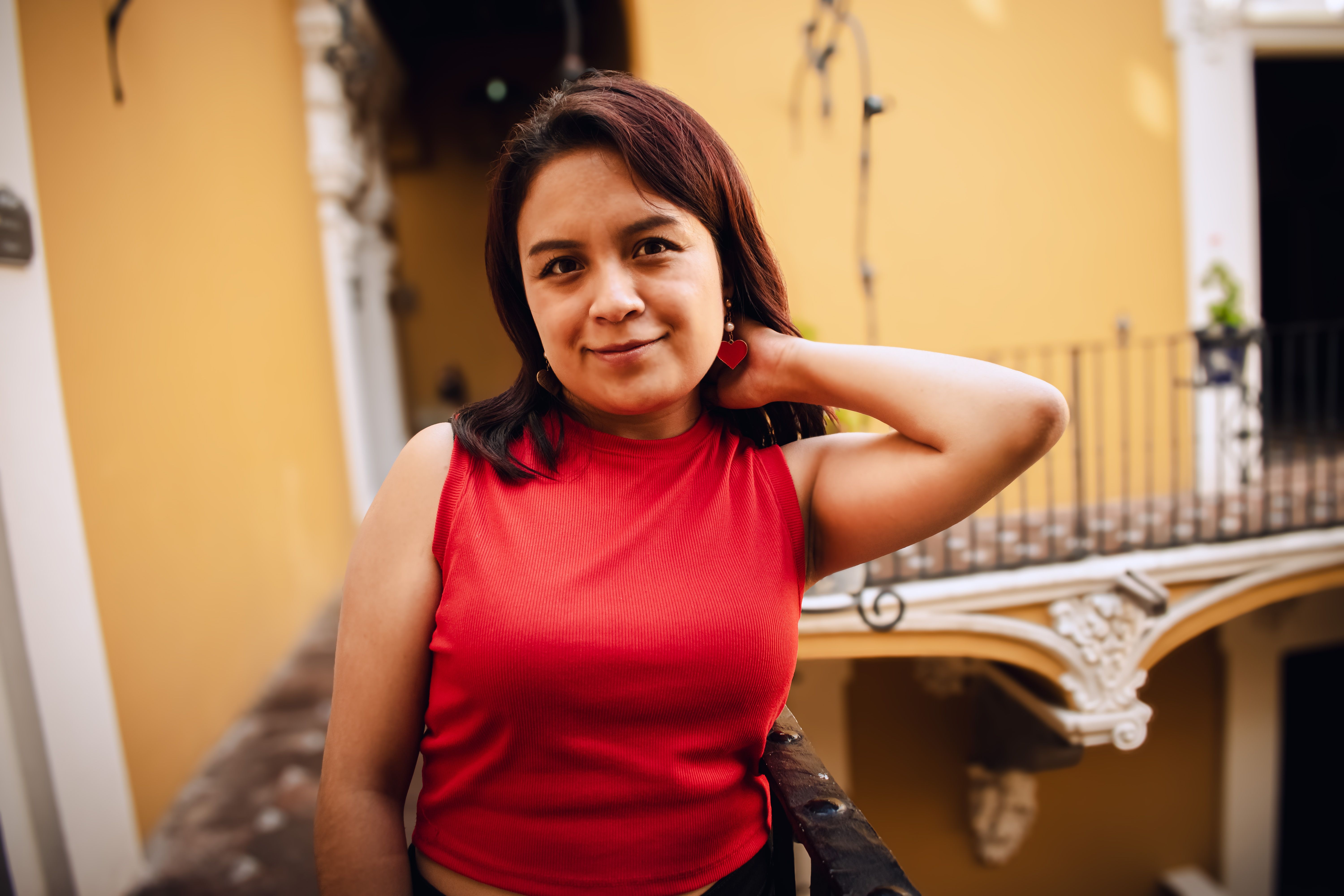 A woman in a red top posing for a photo · Free Stock Photo
