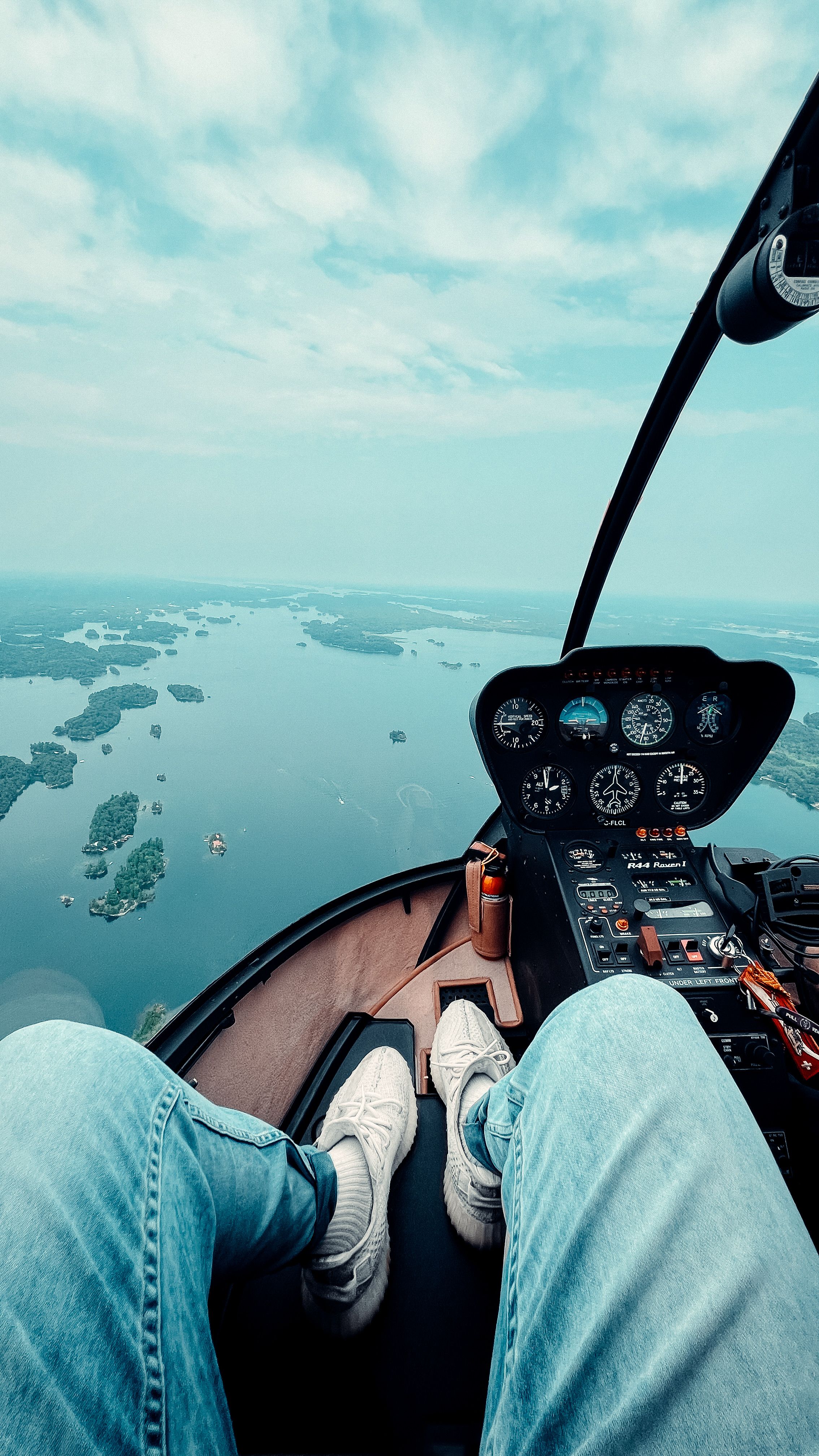 A person sitting in a helicopter with their feet up · Free Stock Photo