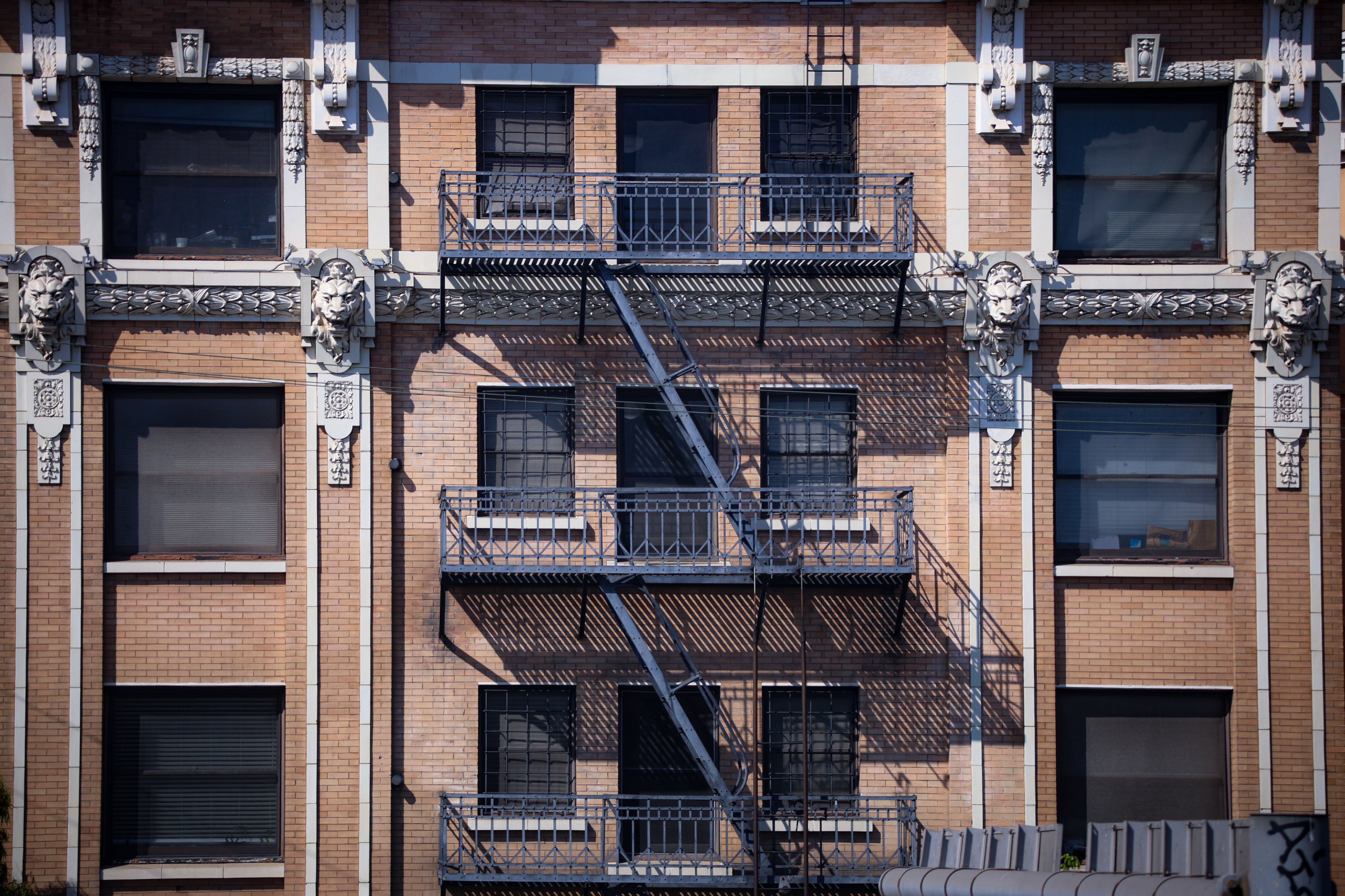 An apartment building with fire escapes and balconies · Free Stock Photo