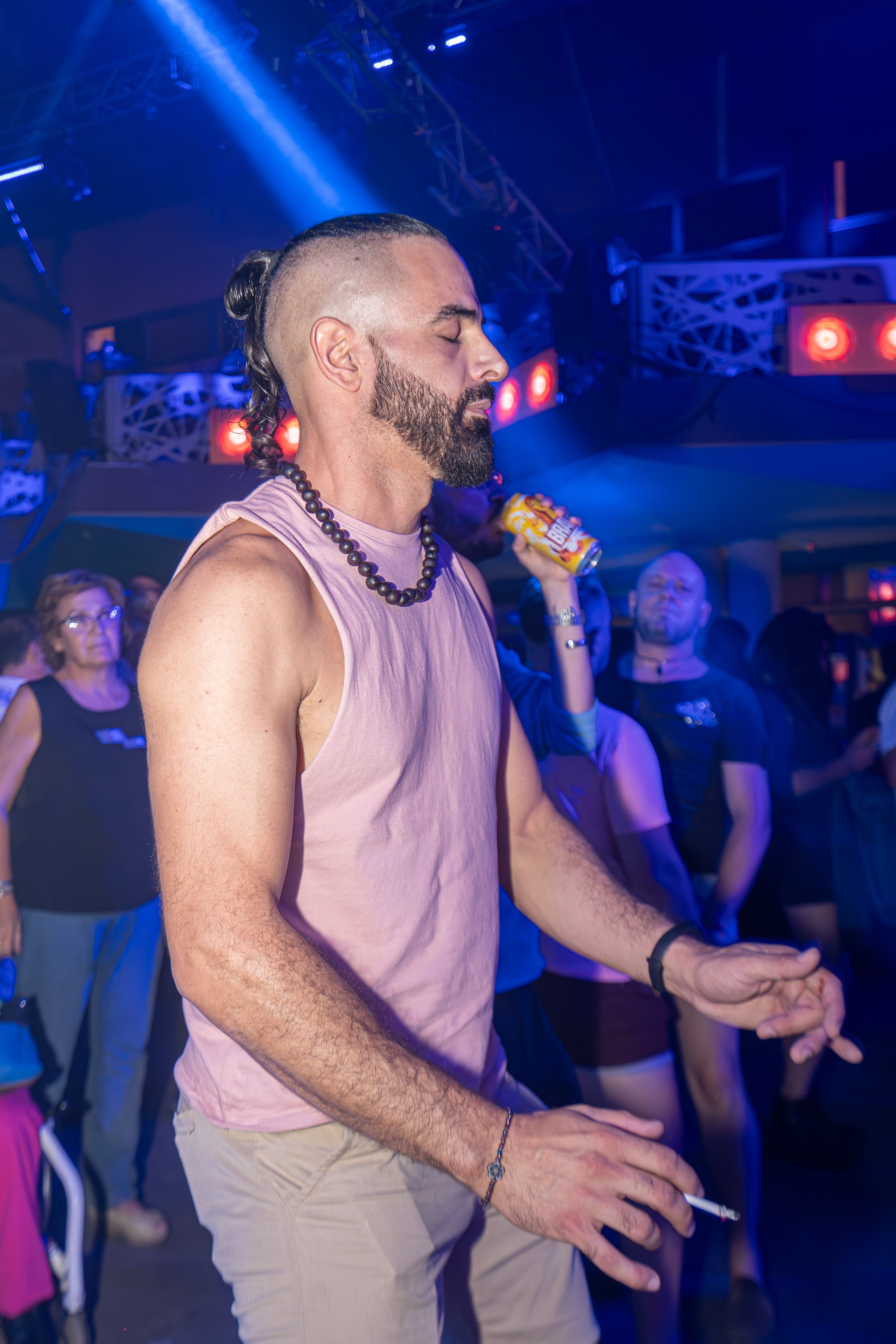 A man in a pink tank top dancing at a party · Free Stock Photo
