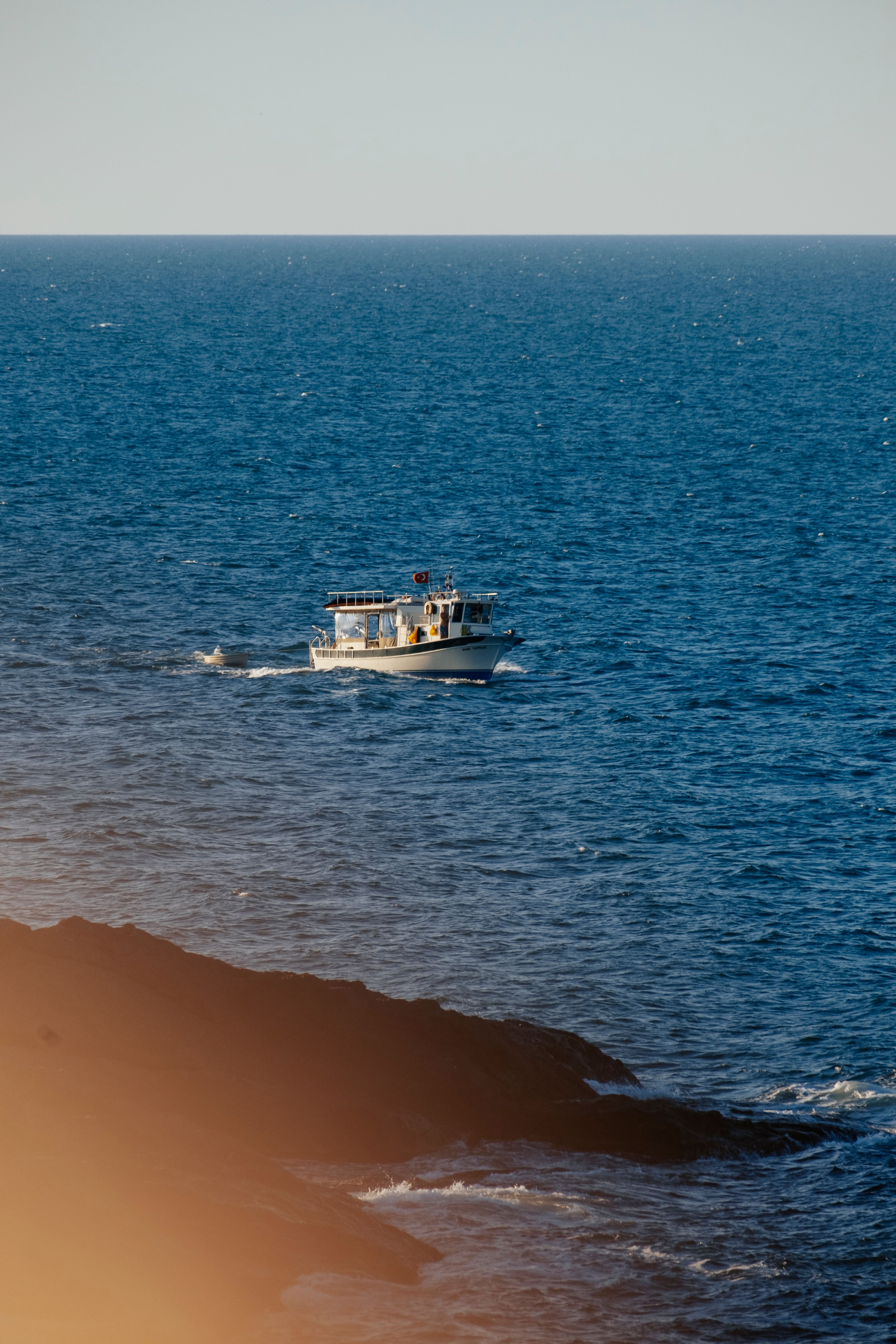 A boat is traveling through the ocean · Free Stock Photo