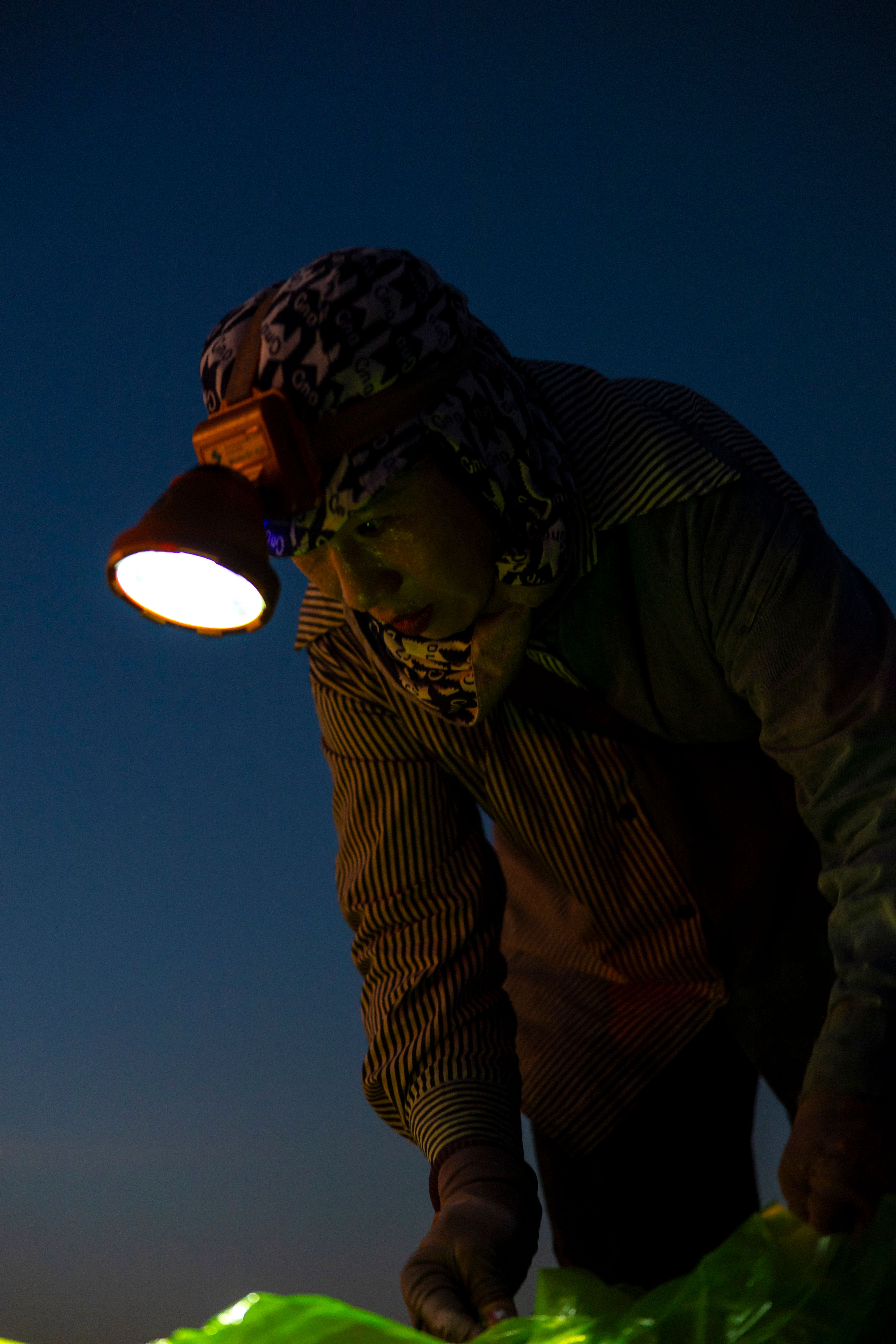 Night Worker with Headlamp in Low Light · Free Stock Photo