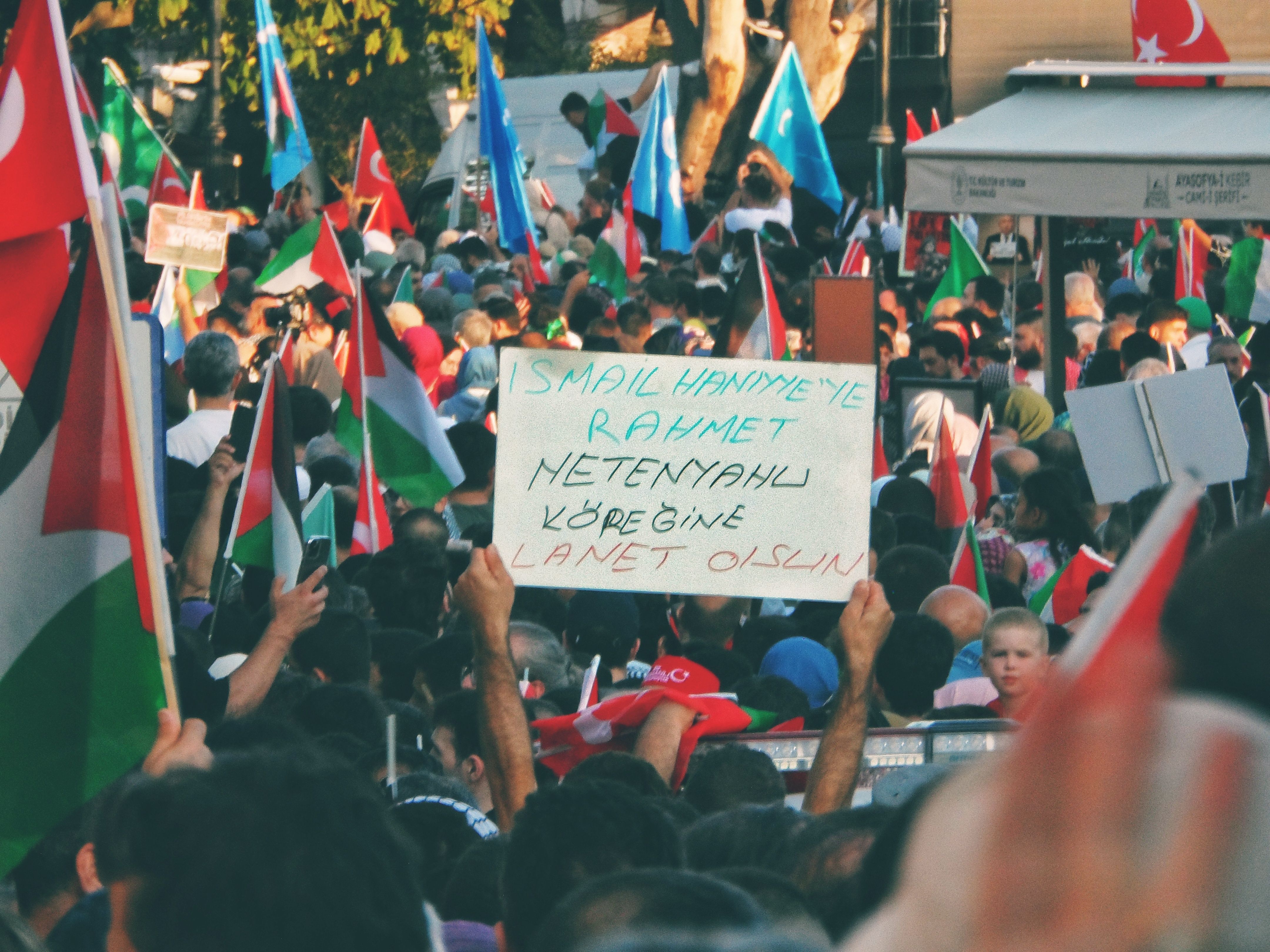 A crowd of people holding signs and flags · Free Stock Photo