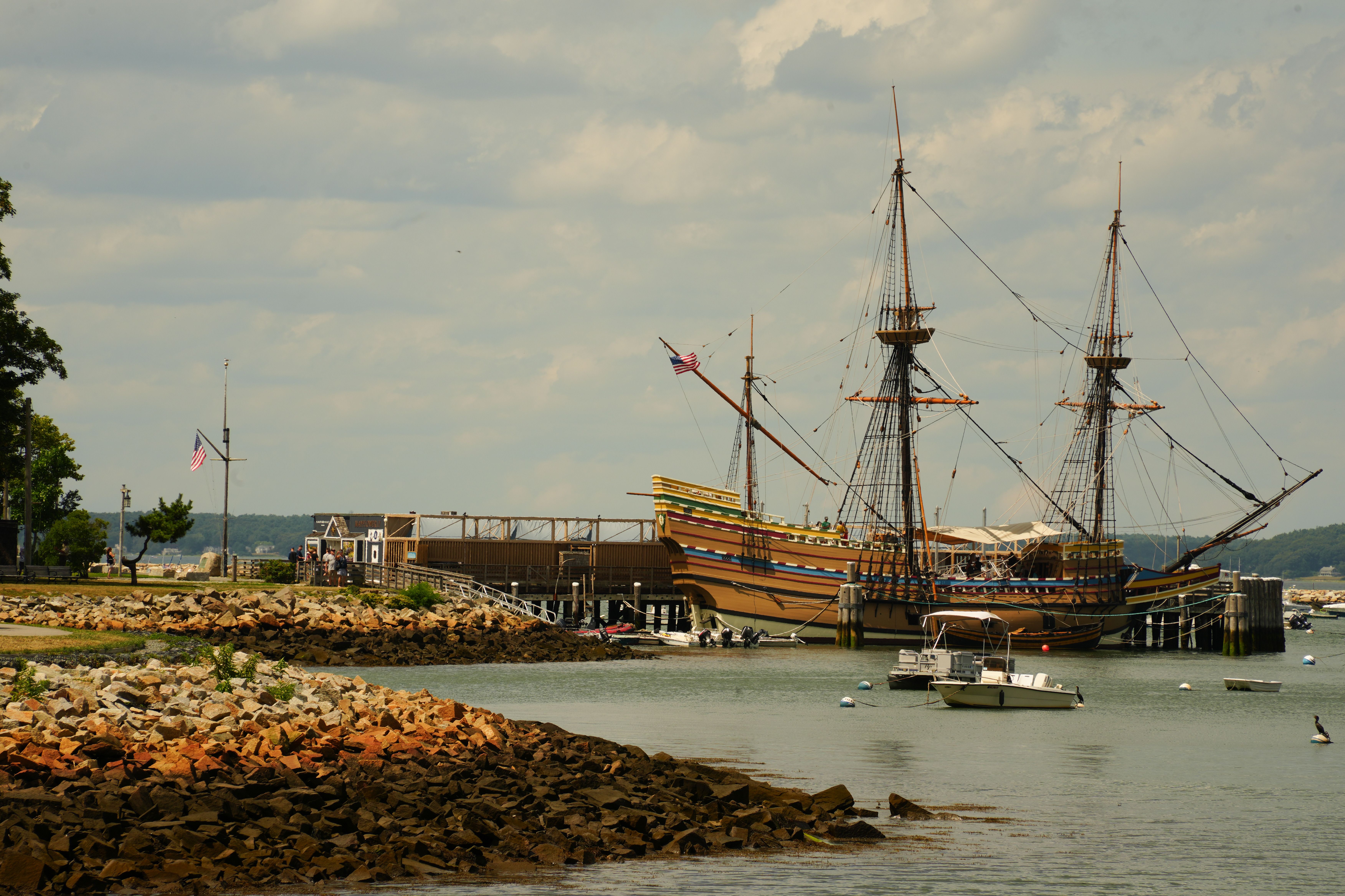 A large ship docked at a harbor with boats in the water · Free Stock Photo
