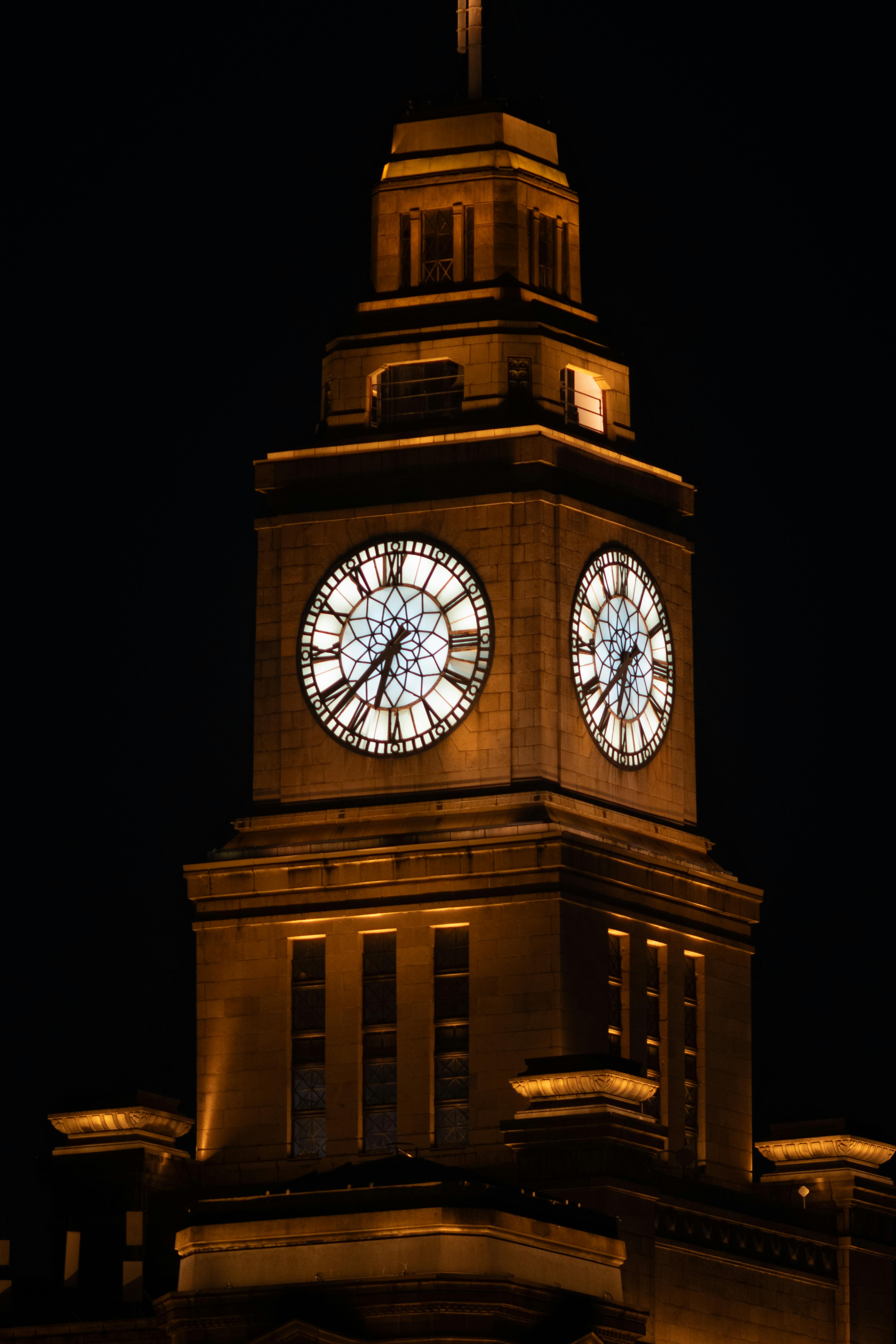 A clock tower with two clocks on it · Free Stock Photo
