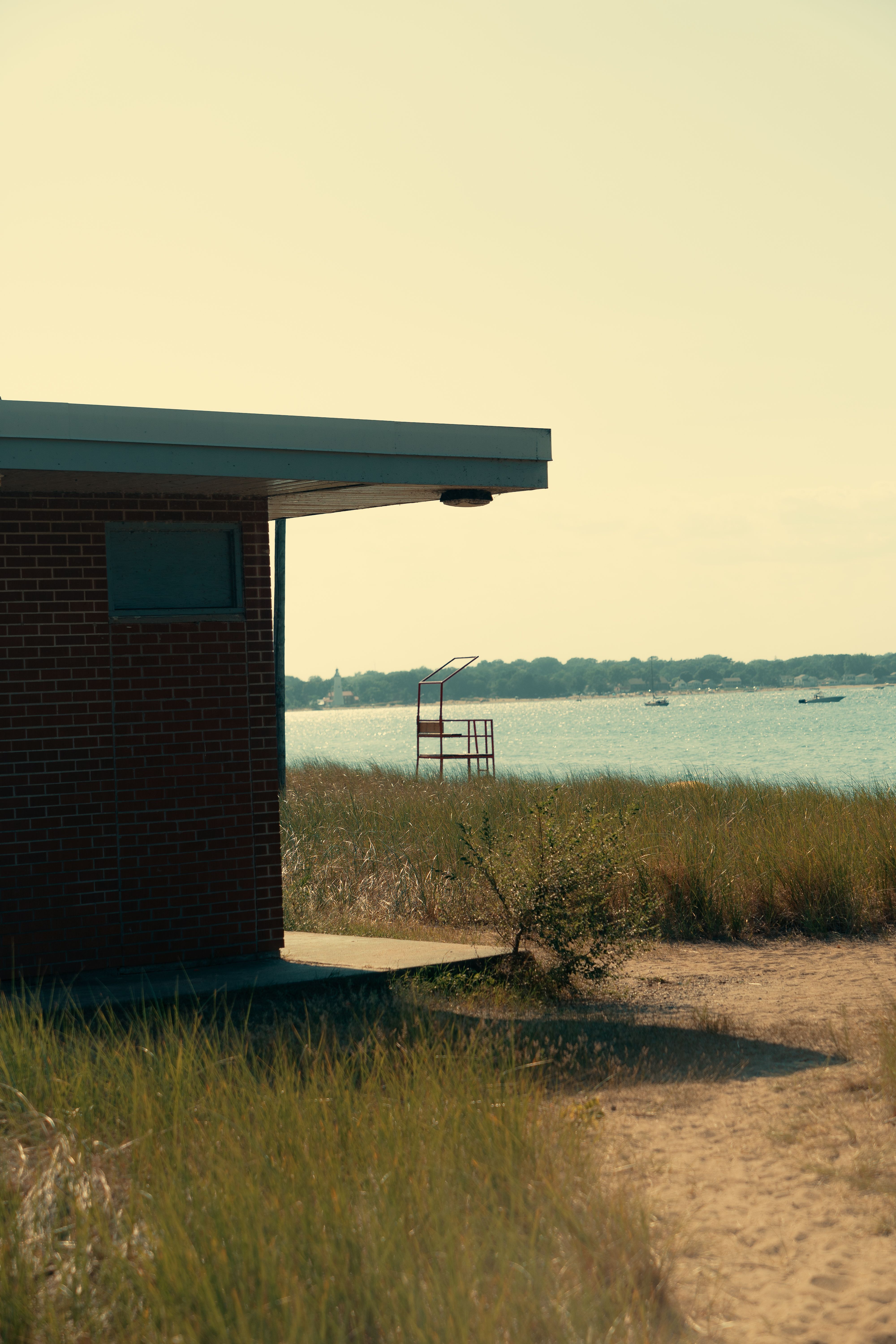 A small building with a door and a beach in the background · Free Stock ...
