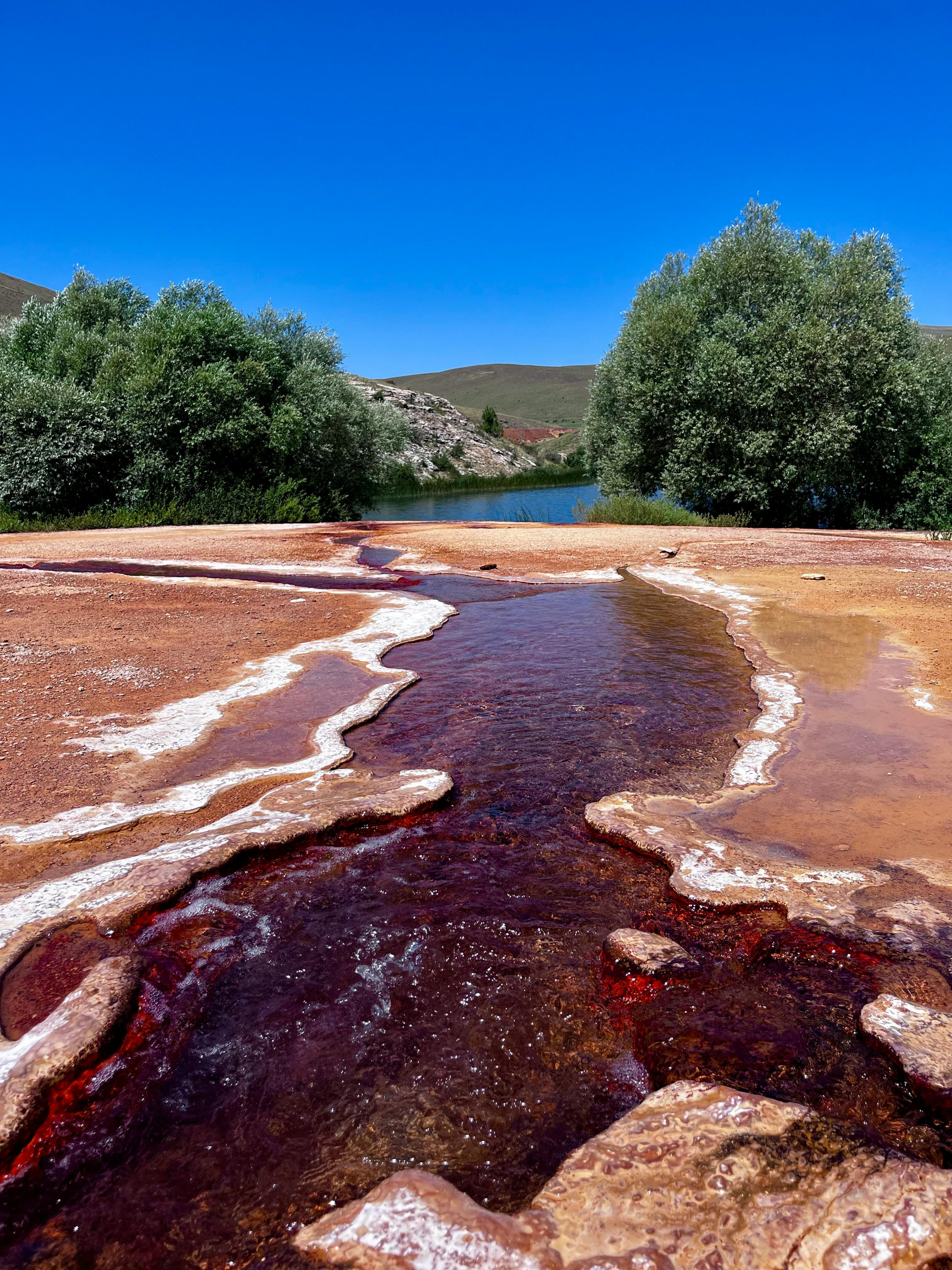 A river with red water and rocks · Free Stock Photo