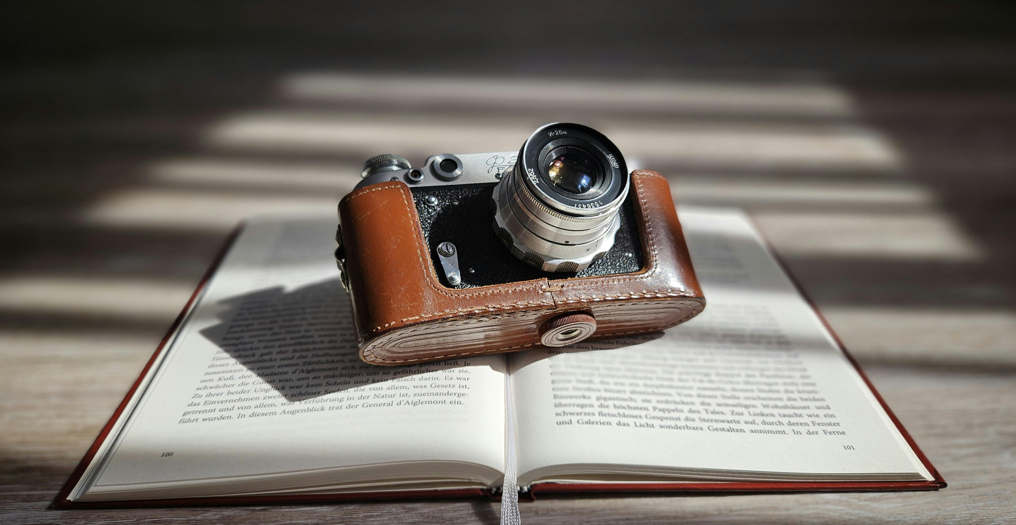 Vintage Camera and Books on Checkered Cloth · Free Stock Photo