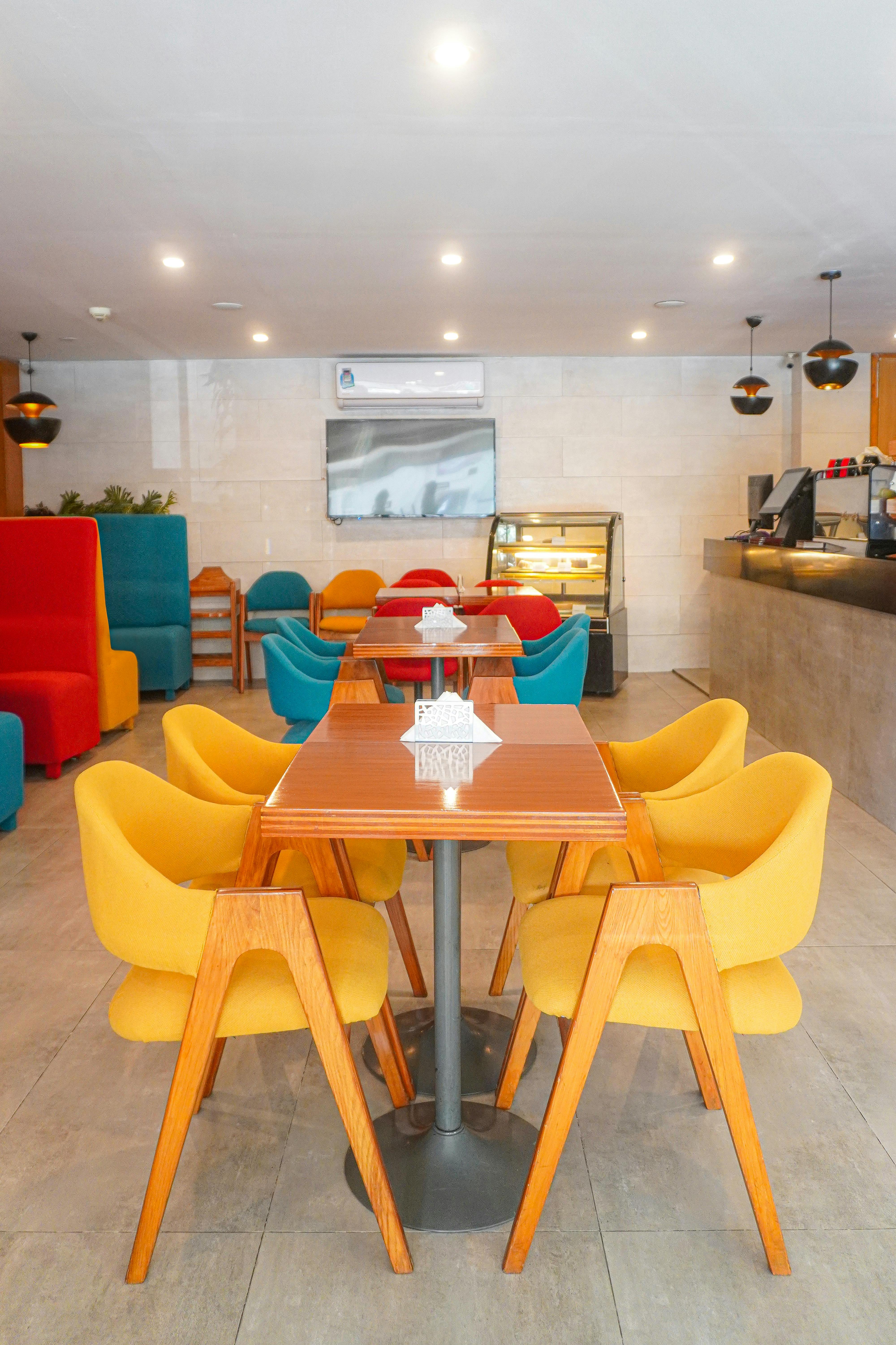 Interior of modern cafe with tables and chairs · Free Stock Photo