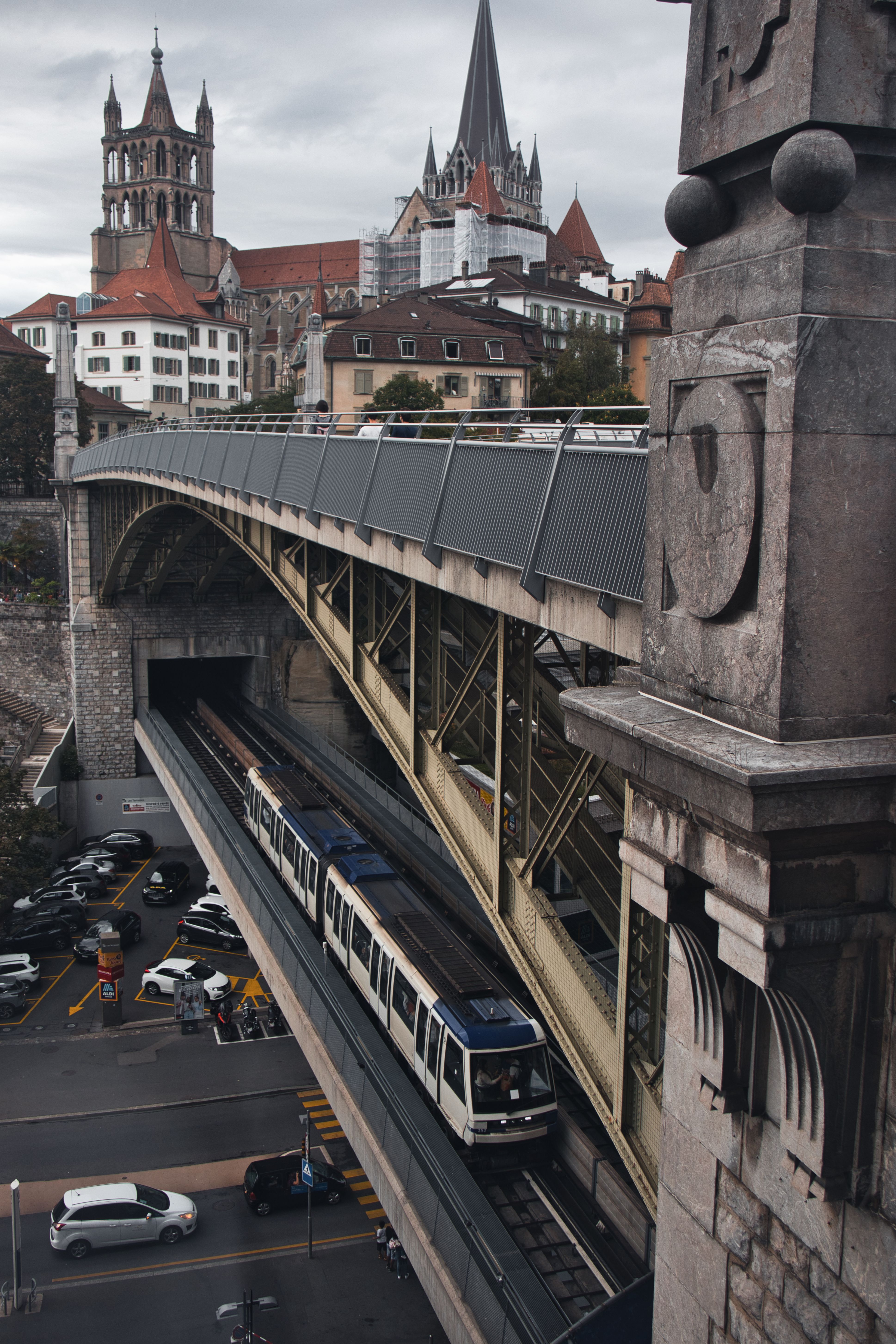 A Lausanne Métro train passes over the Bessières Bridge · Free Stock Photo