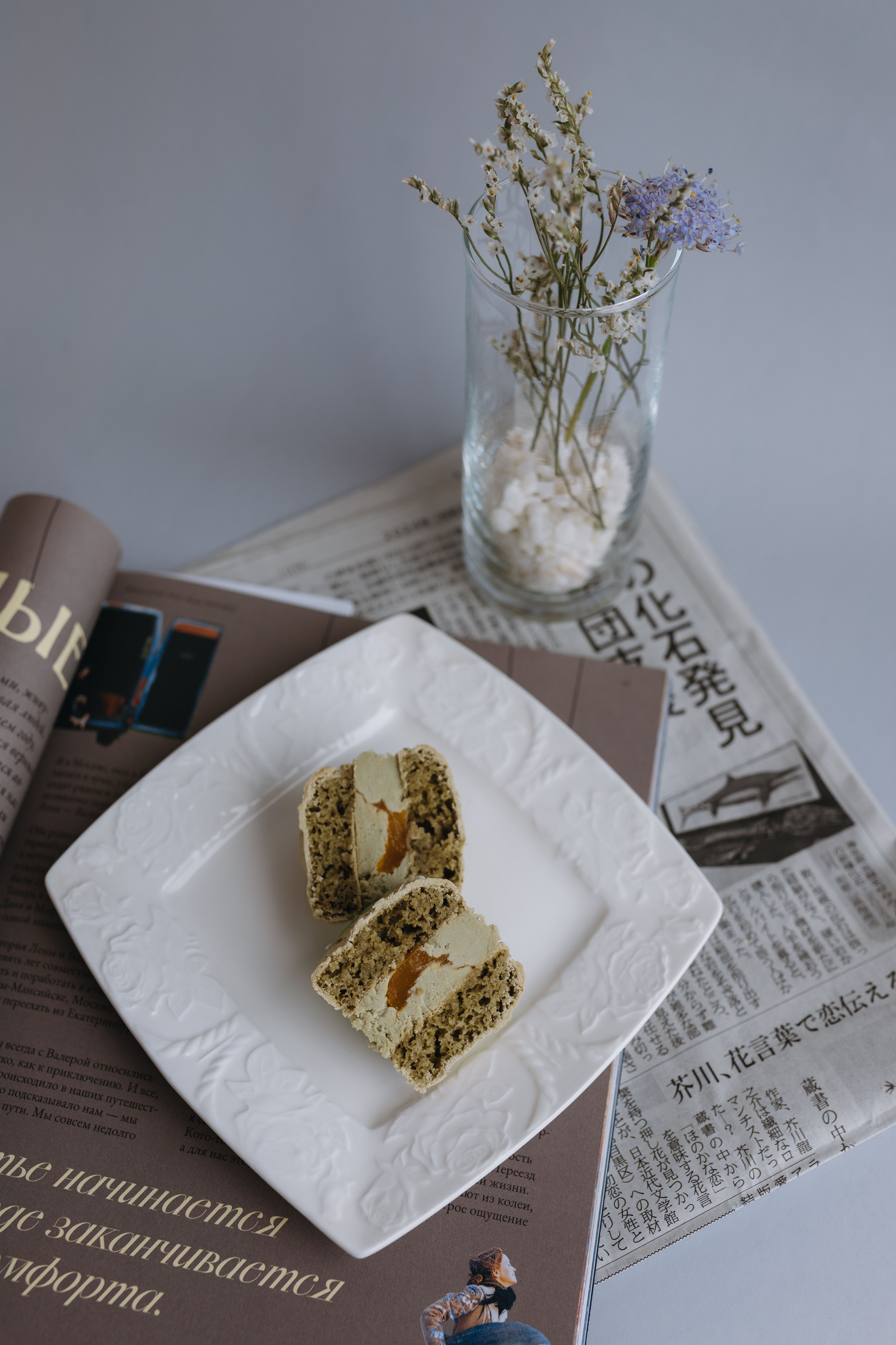 A plate of food on a newspaper with a flower · Free Stock Photo