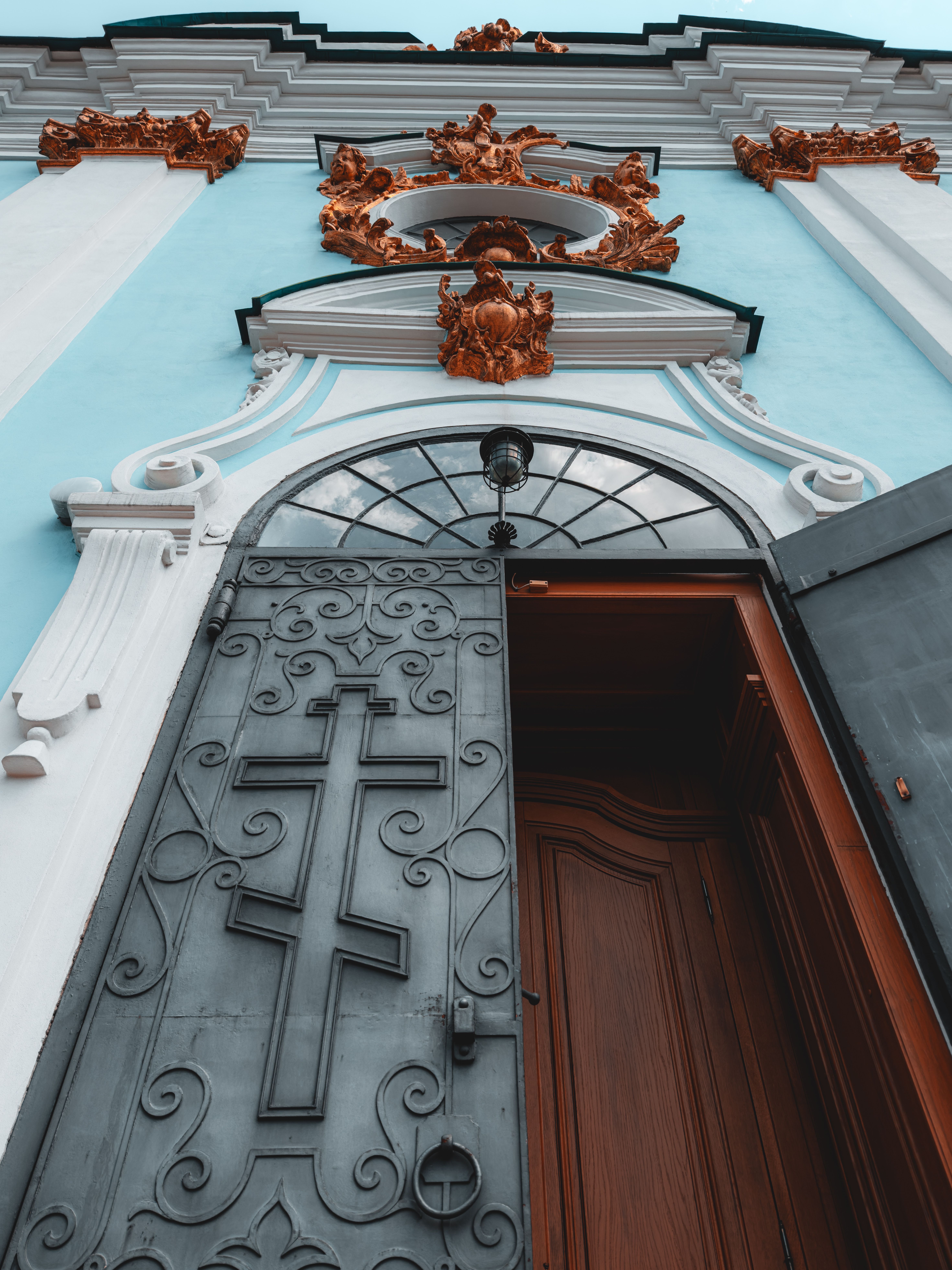 A door with ornate designs on it and a cross on the door · Free Stock Photo