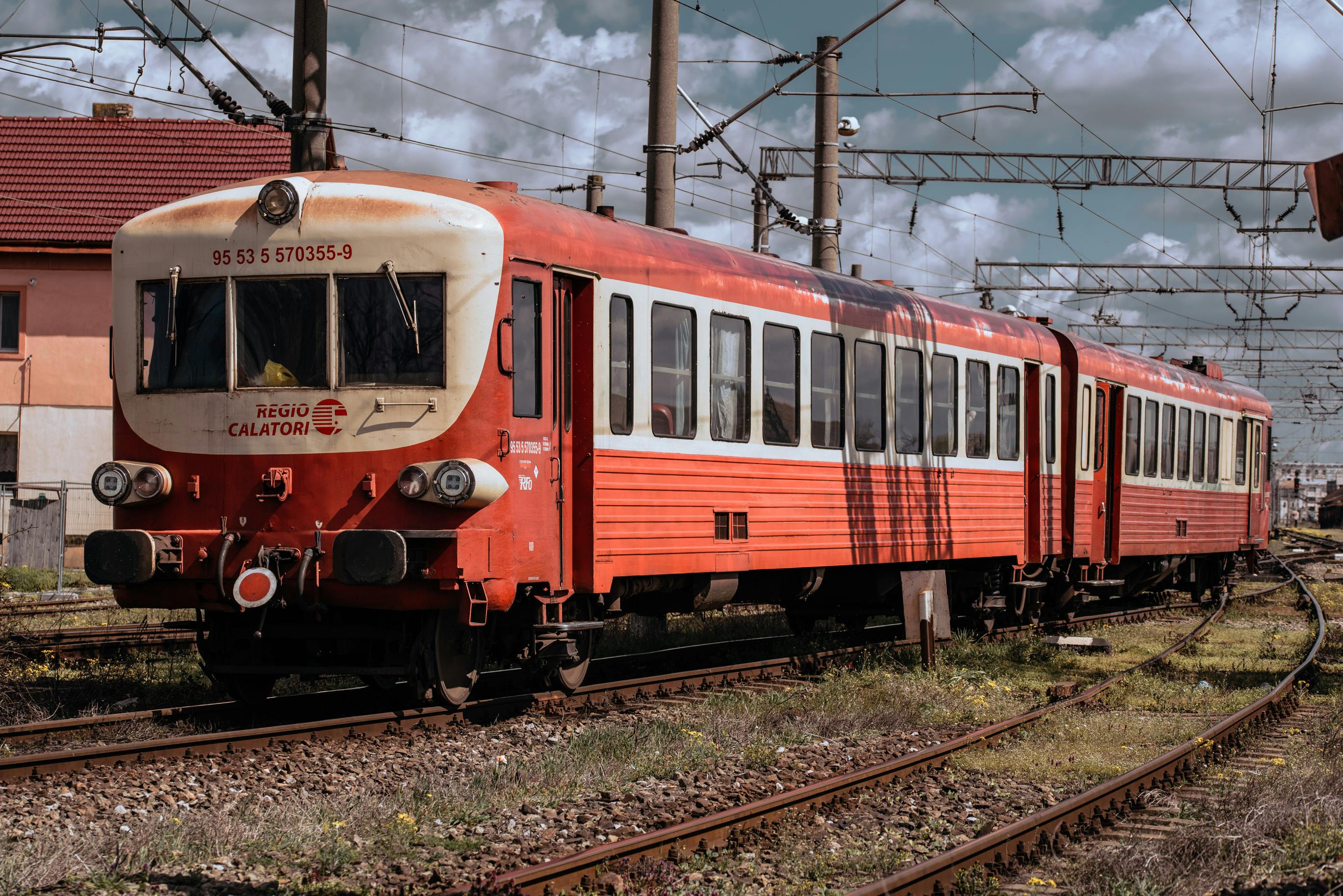 Red Train on Black Steel Train Rail during Day · Free Stock Photo
