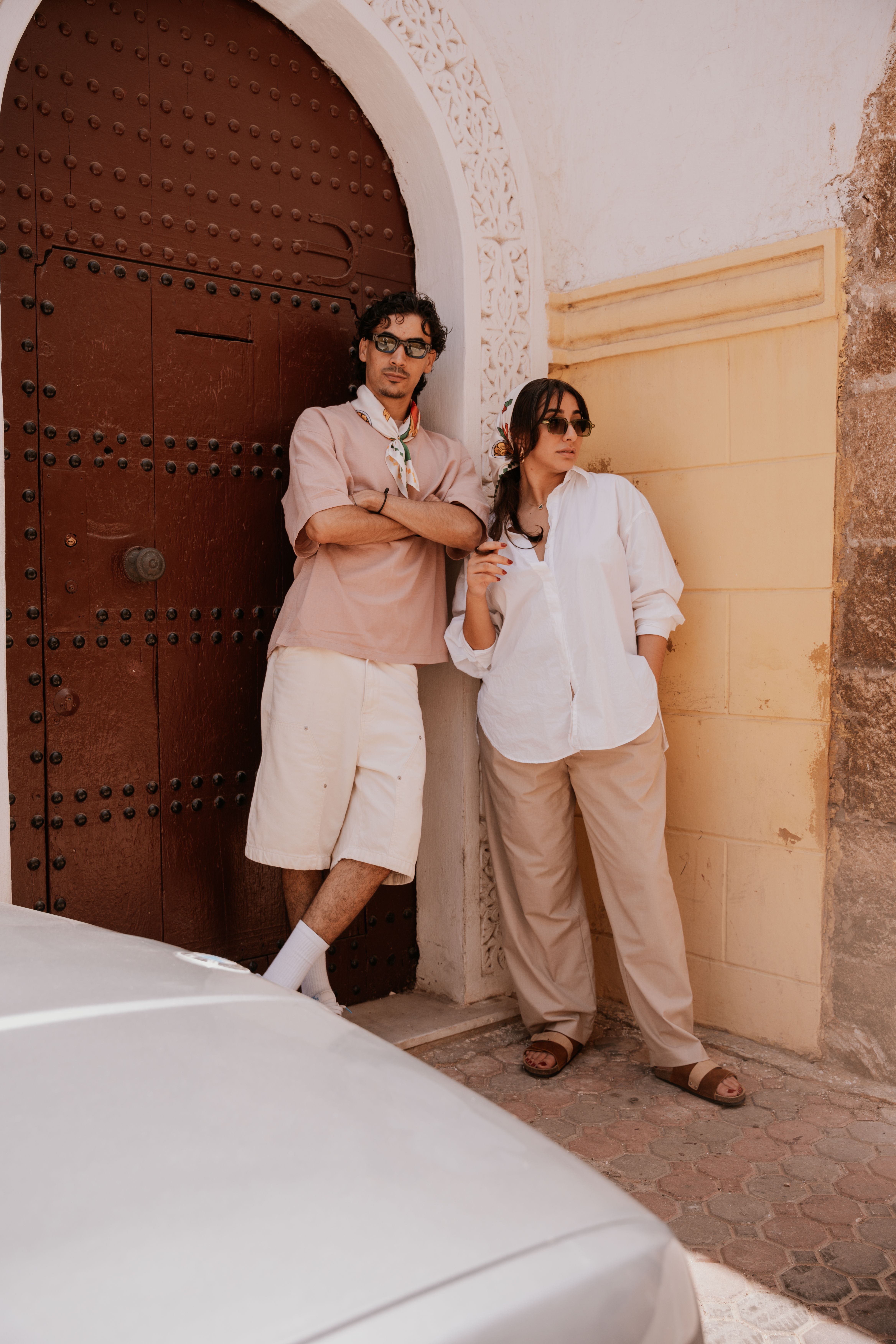 Two people standing in front of a car · Free Stock Photo