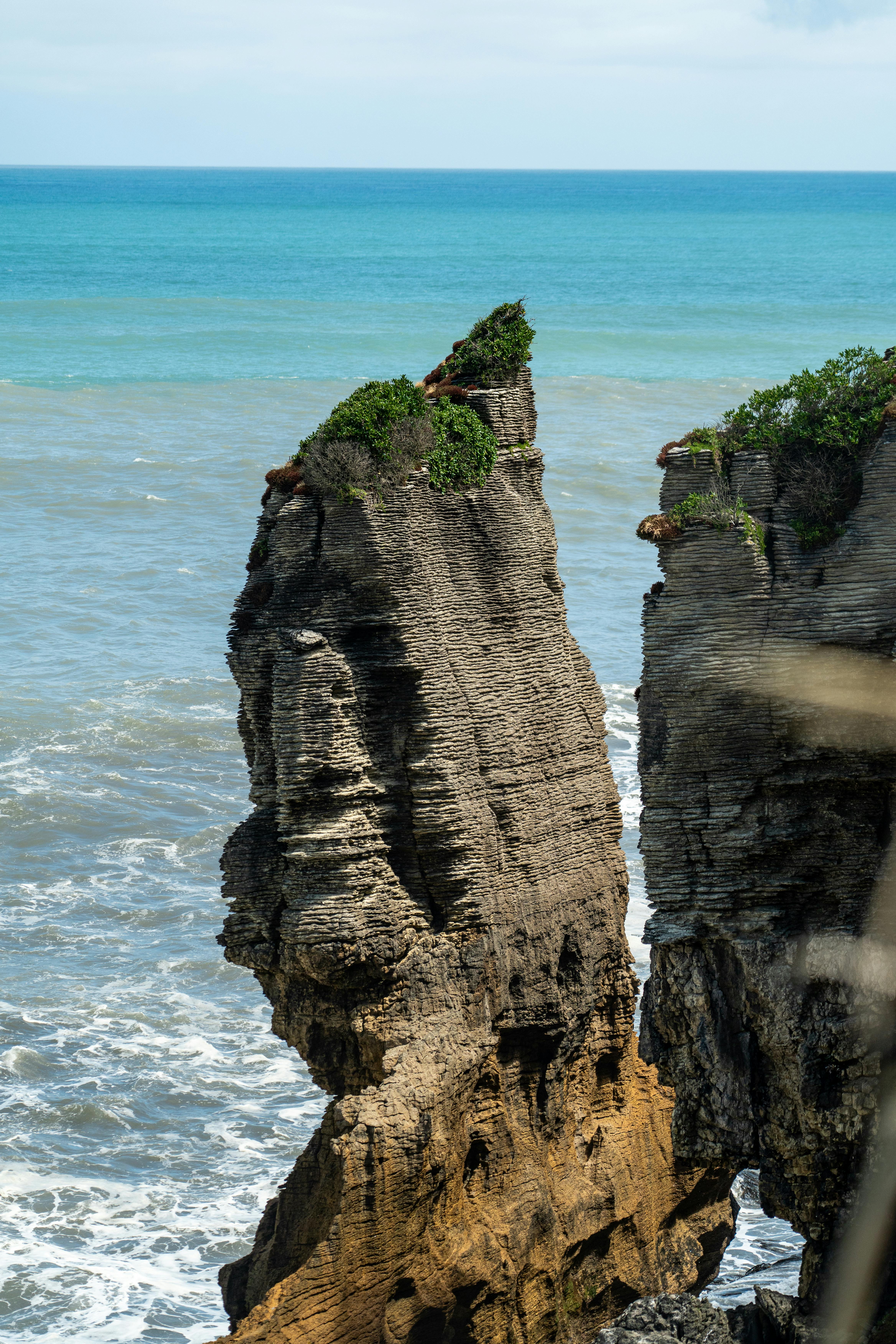 Two rock formations on the edge of the ocean · Free Stock Photo