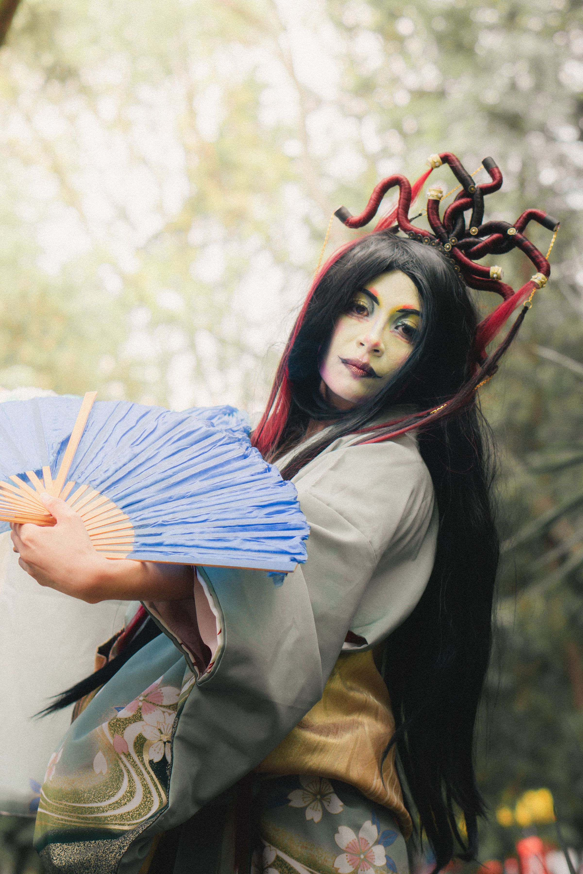 A woman dressed as a geisha holding a fan · Free Stock Photo