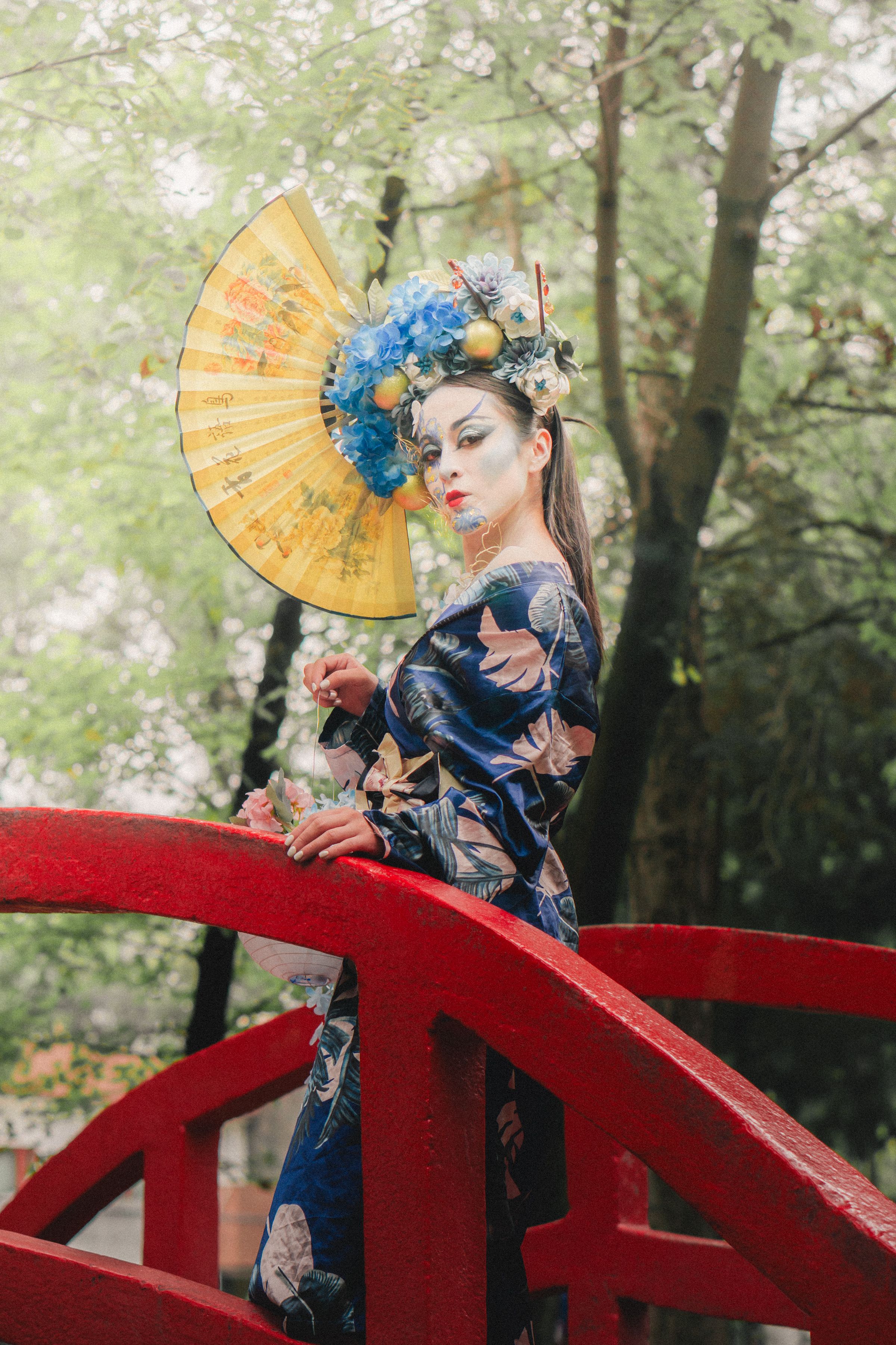 A woman in a geisha costume holding a fan · Free Stock Photo