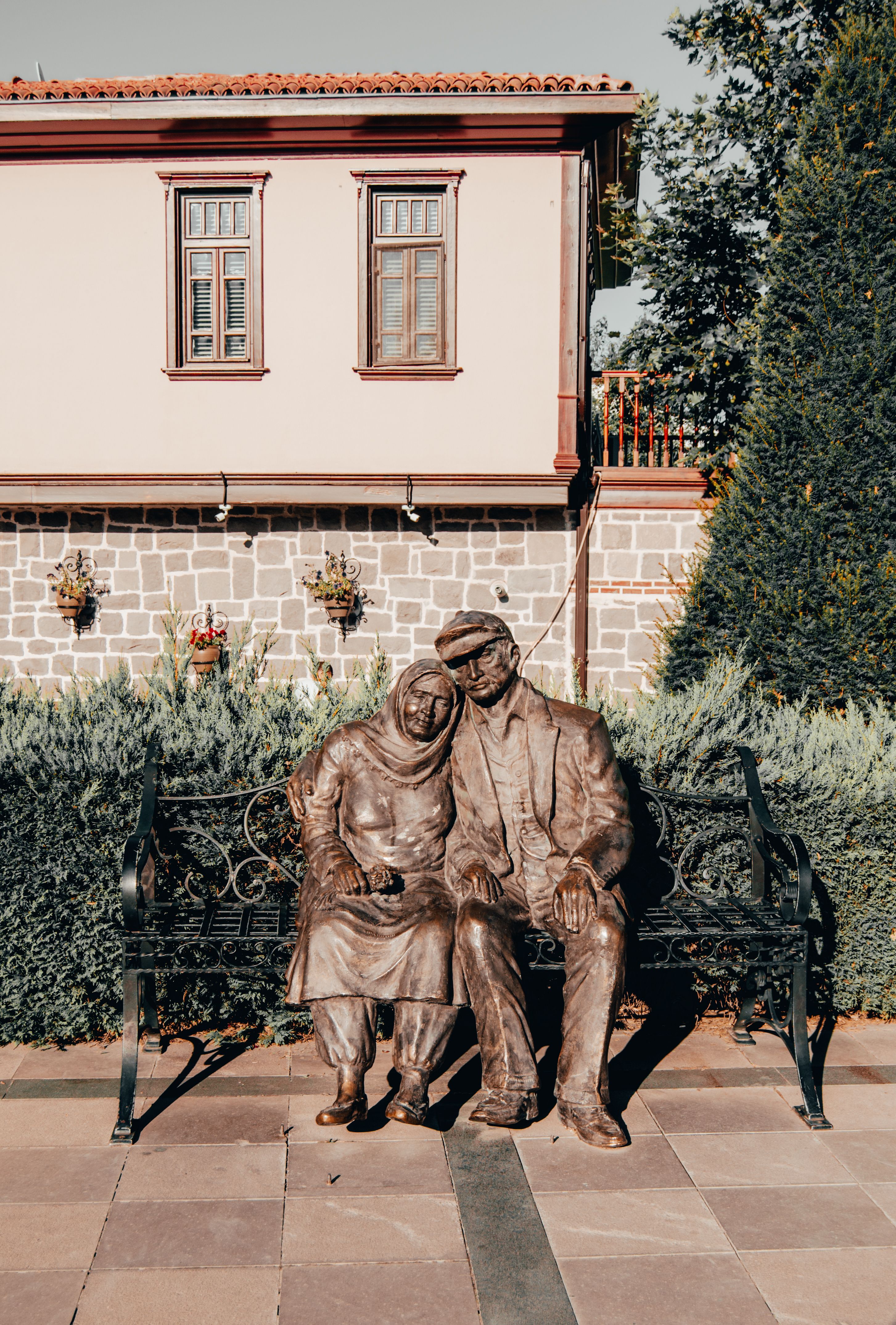A statue of a couple sitting on a bench · Free Stock Photo