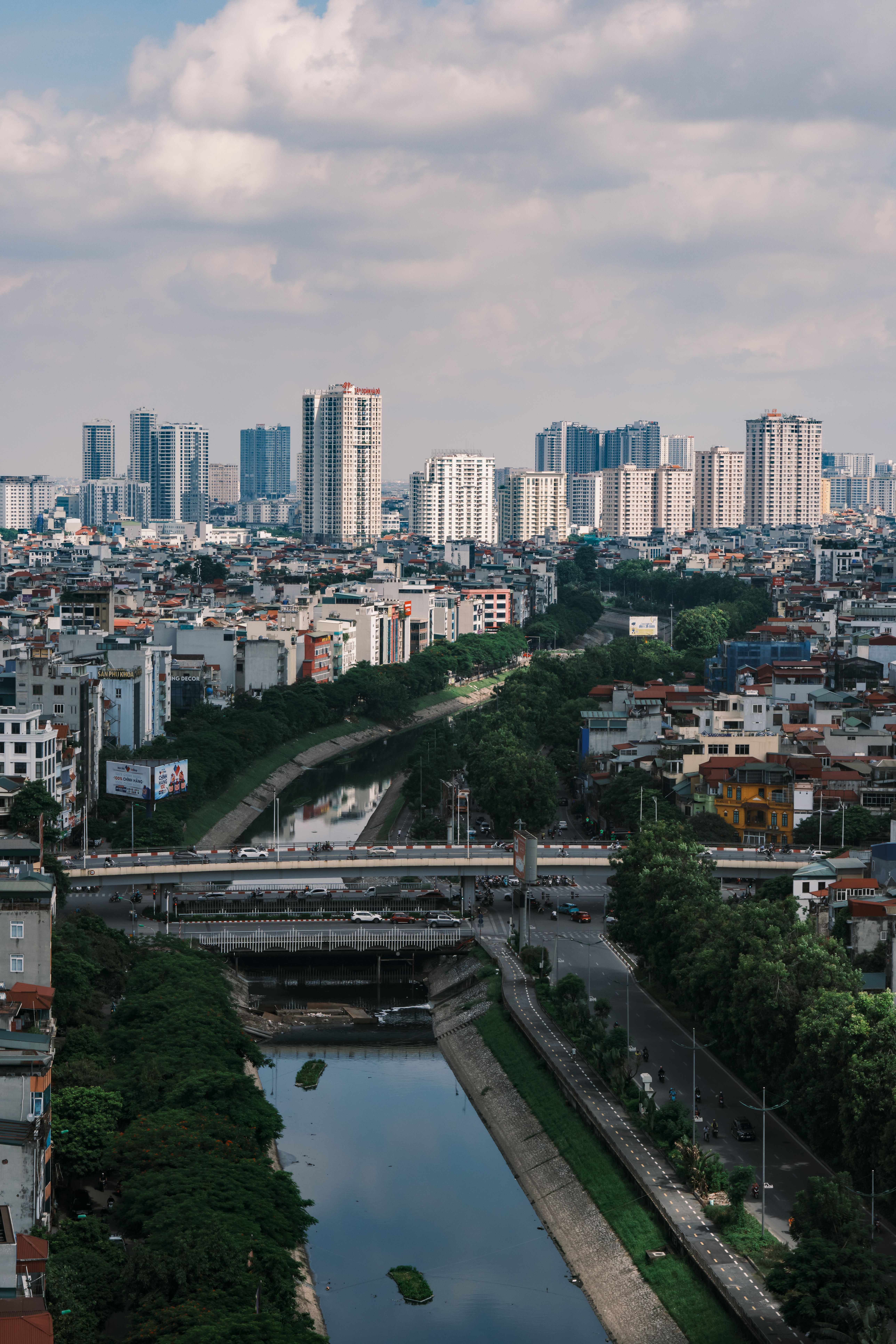 A river runs through a city with tall buildings · Free Stock Photo