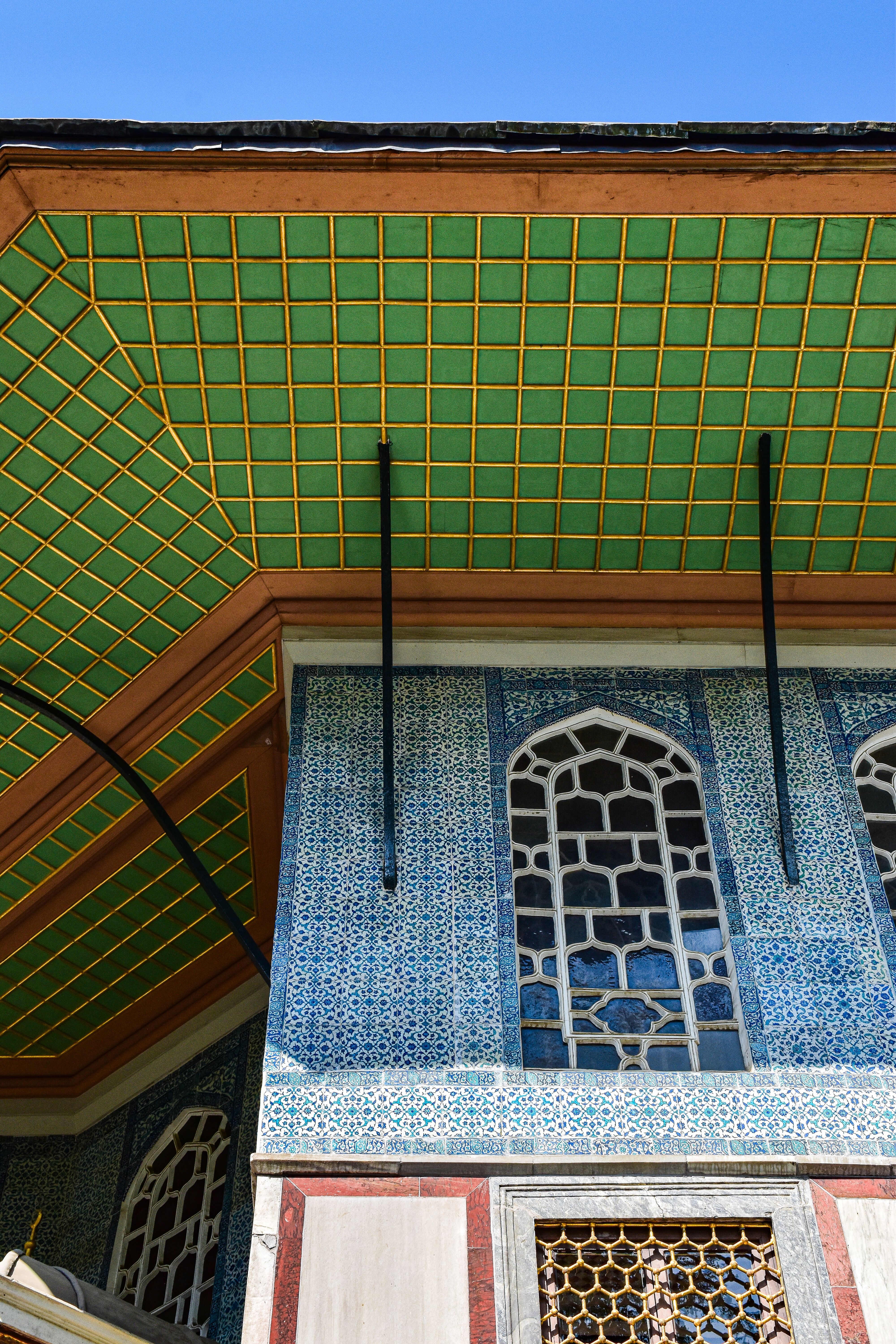 The roof of a building with a green and blue tile · Free Stock Photo