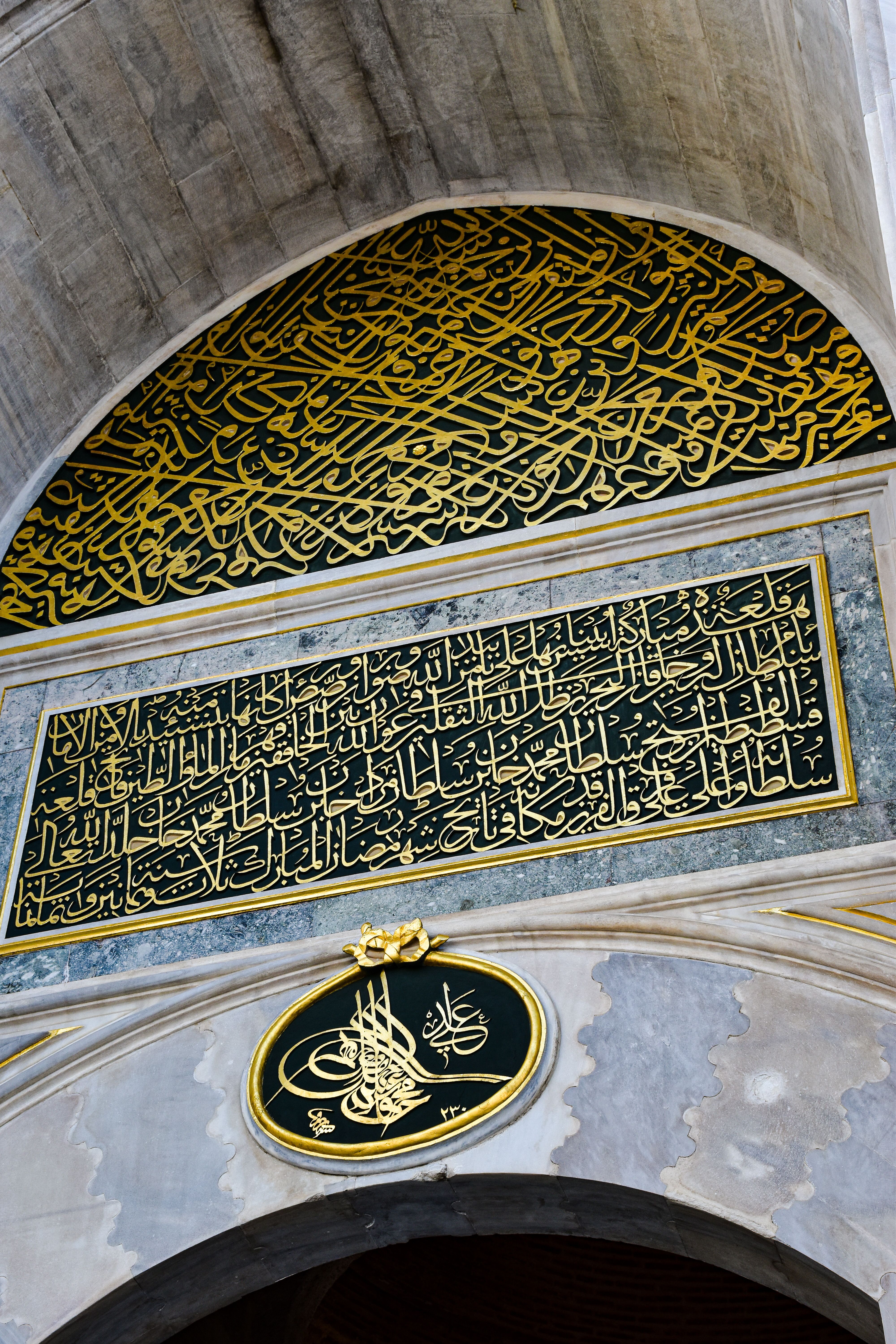 The entrance to the mosque has a gold and black calligraphy · Free ...
