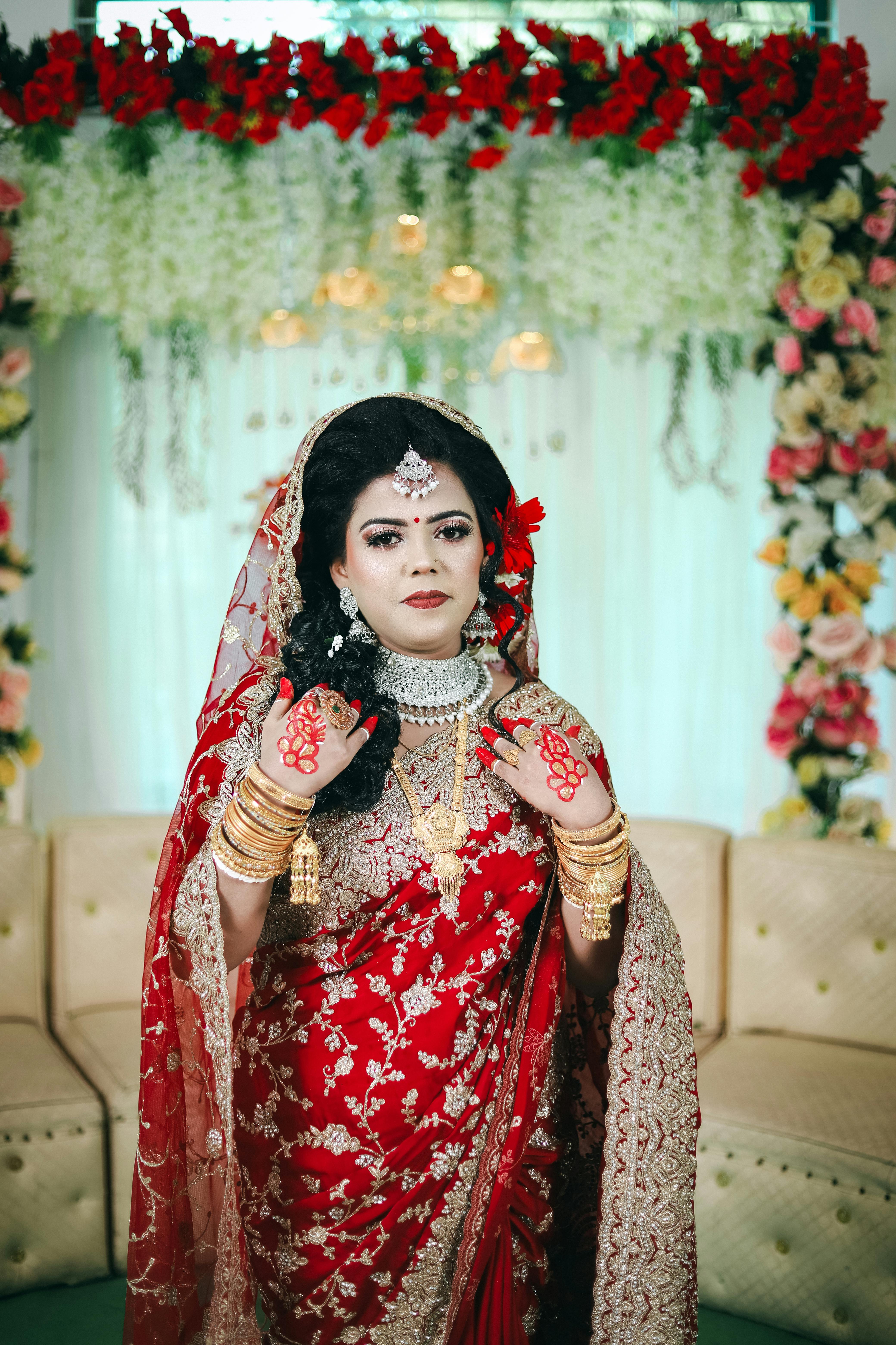 A bride in red and gold sari · Free Stock Photo