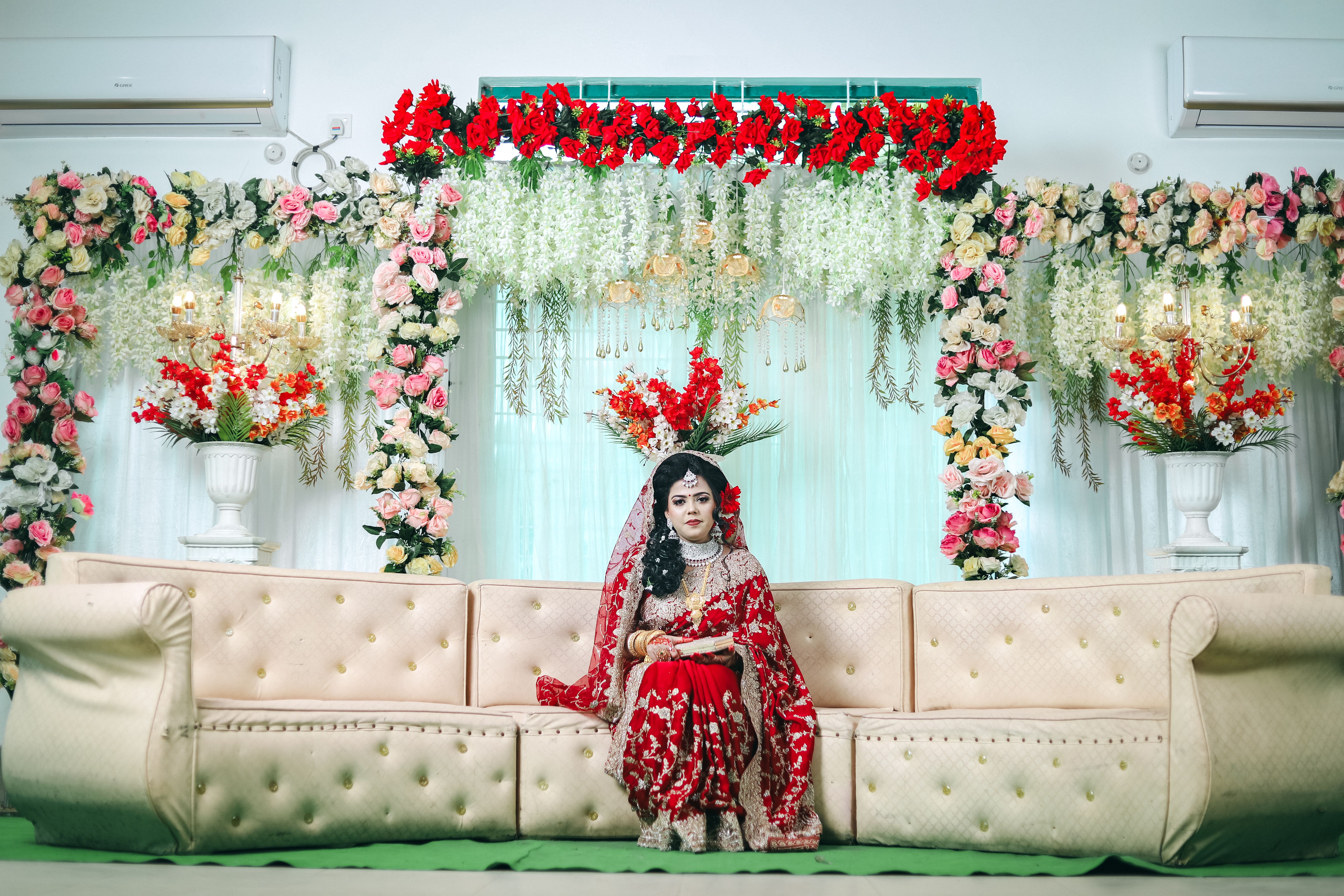A bride sitting on a couch in a wedding setting · Free Stock Photo